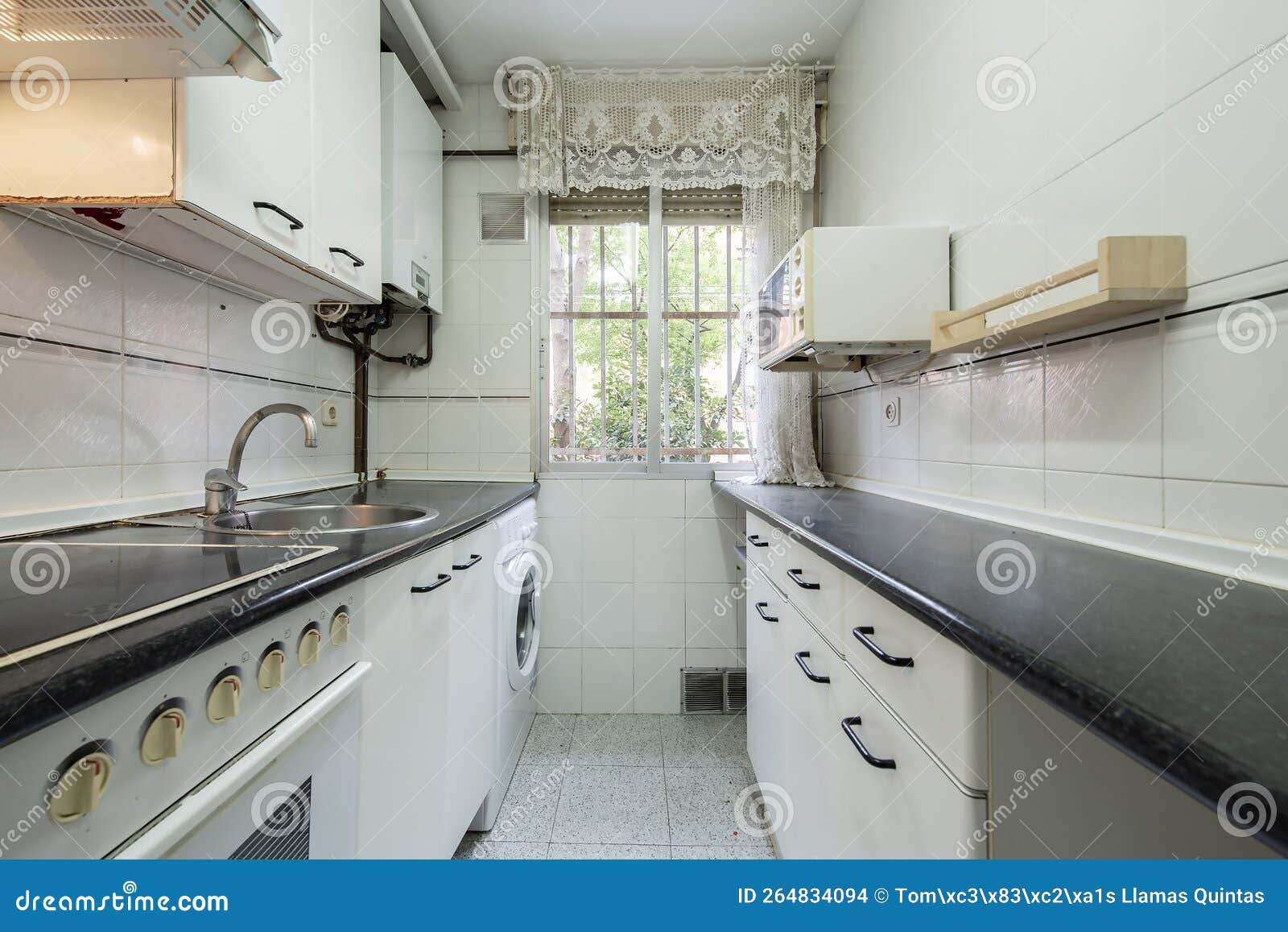 Narrow Kitchen with Cabinets on Both Sides of the Wall with White ...