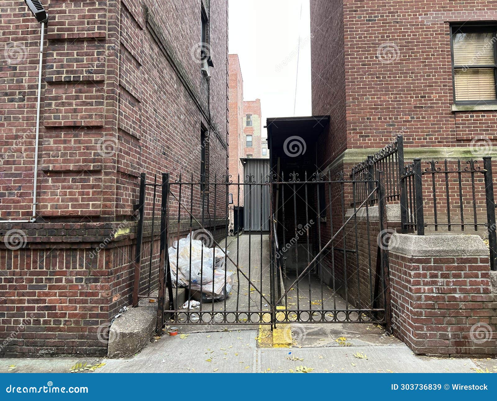 Narrow Path with a Metal Gate between Brick Buildings Stock Image ...