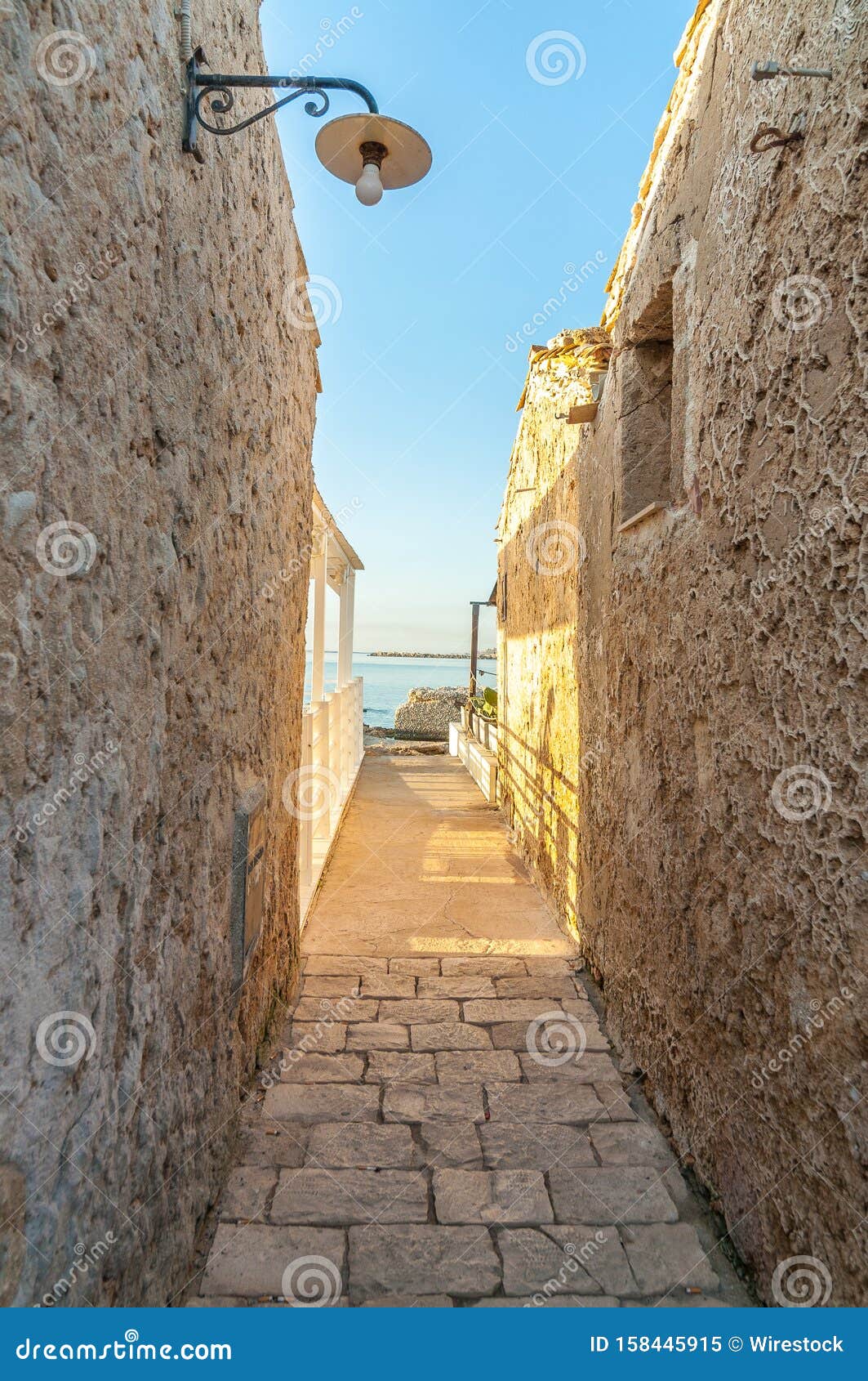 Narrow Pathway Between Low Stone Buildings Of A Coastal Town Royalty ...
