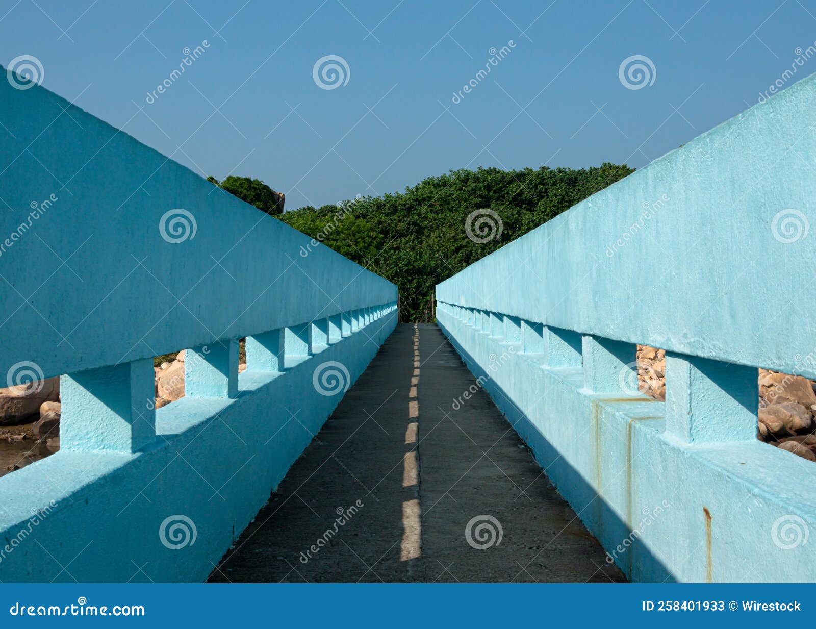 Narrow Pathway between Two Blue Walls and Trees in the End of it Stock ...