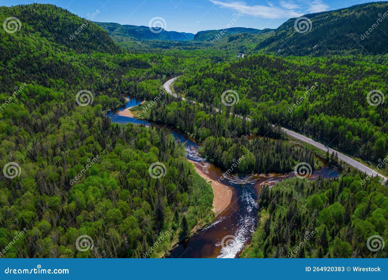 Narrow River and Road between Trees and Greenery with Mountains in the ...