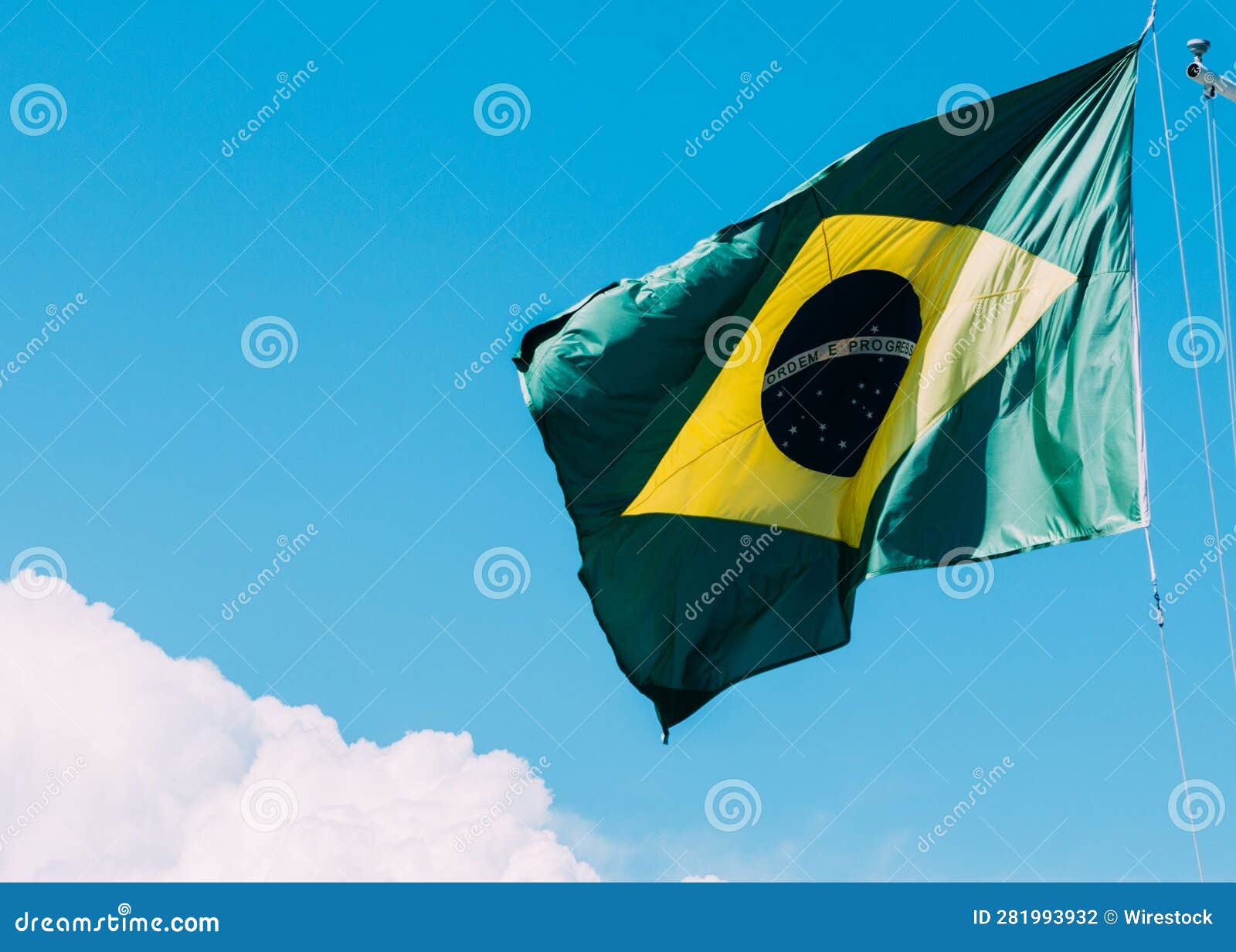 National Flag of Brazil Waving Against the Backdrop of the Blue Sky ...