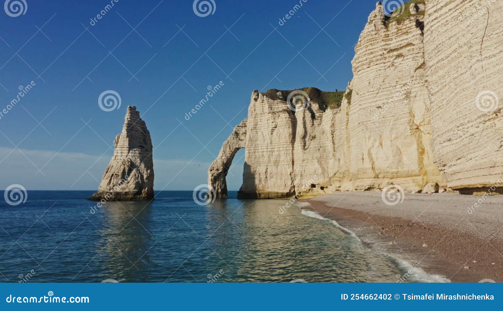 A Natural Arch in a Sheer Cliff and a Sharp Peak of a Rock Standing Out ...
