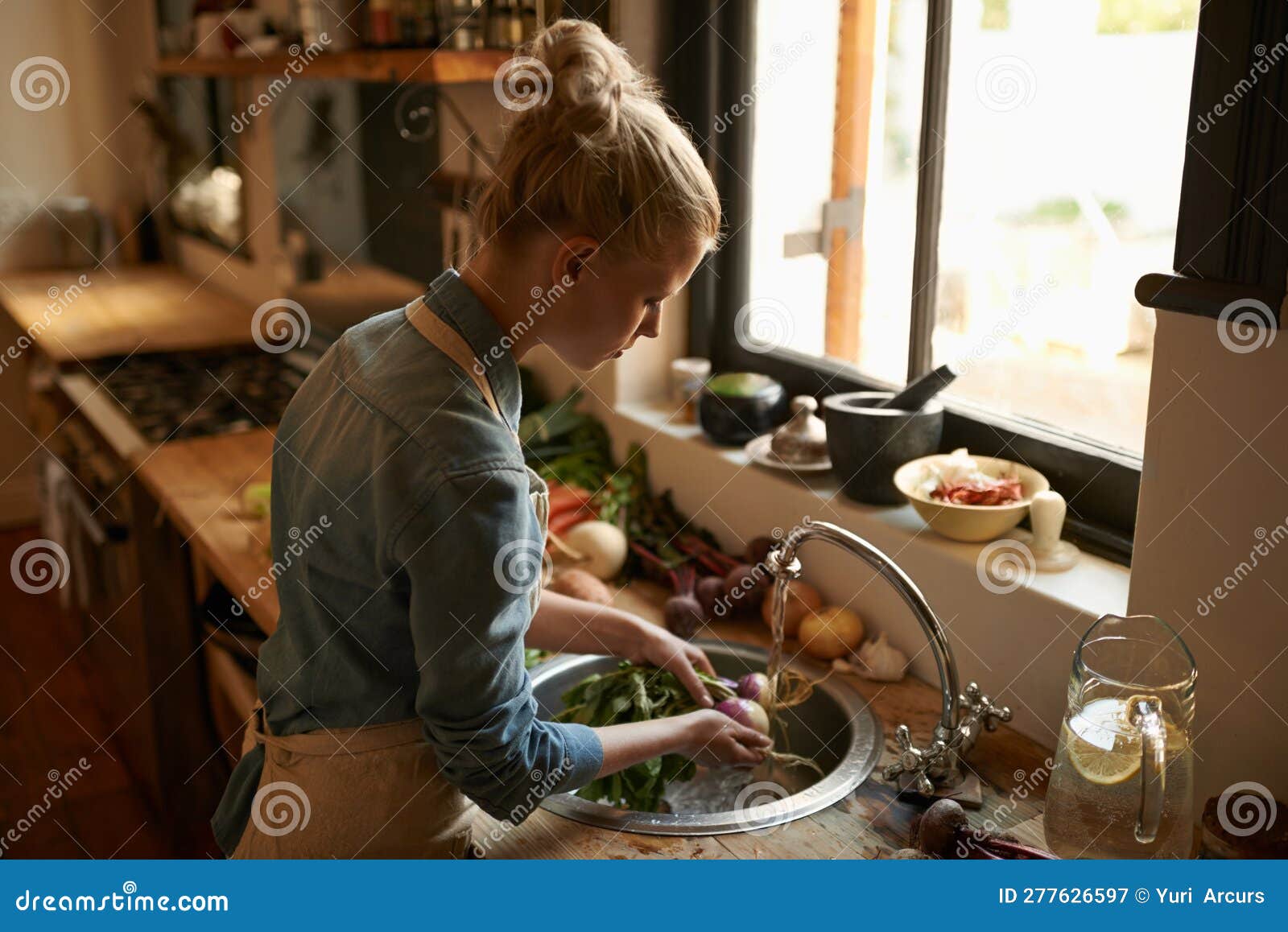 She a Natural in the Kitchen. a Young Woman Washing Vegetables in a ...