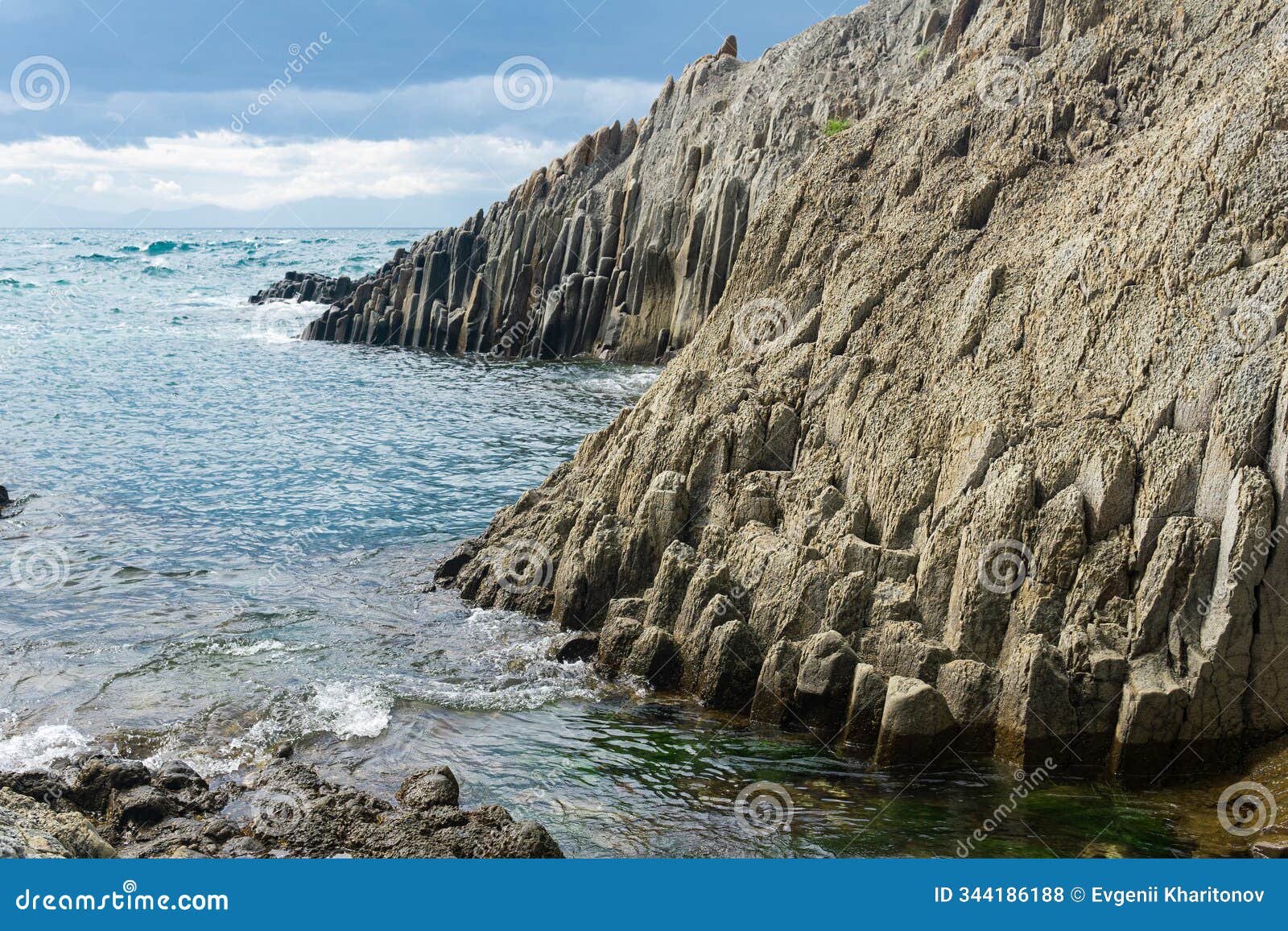 Natural Landscape with a Sheer Cliff Folded Columnar Basalt on the Seashore Stock Photo - Image ...