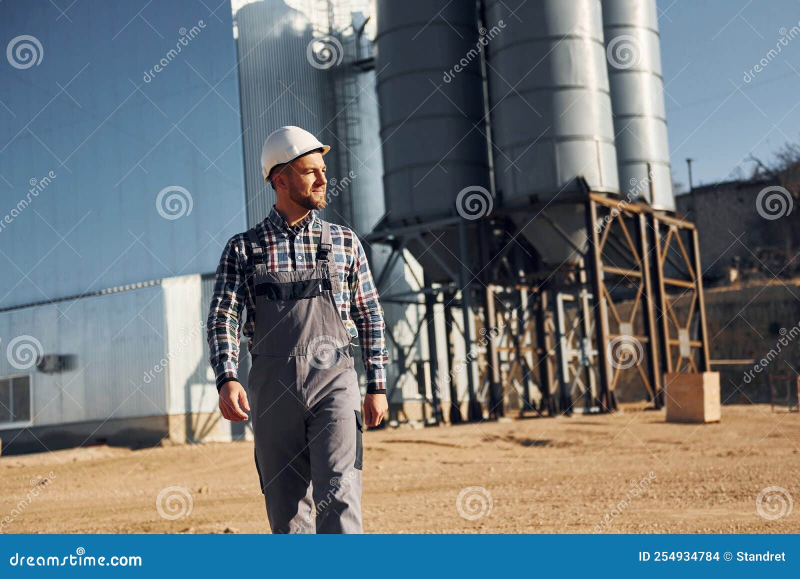 Natural Lighting. Construction Worker in Uniform is Outdoors Near the ...