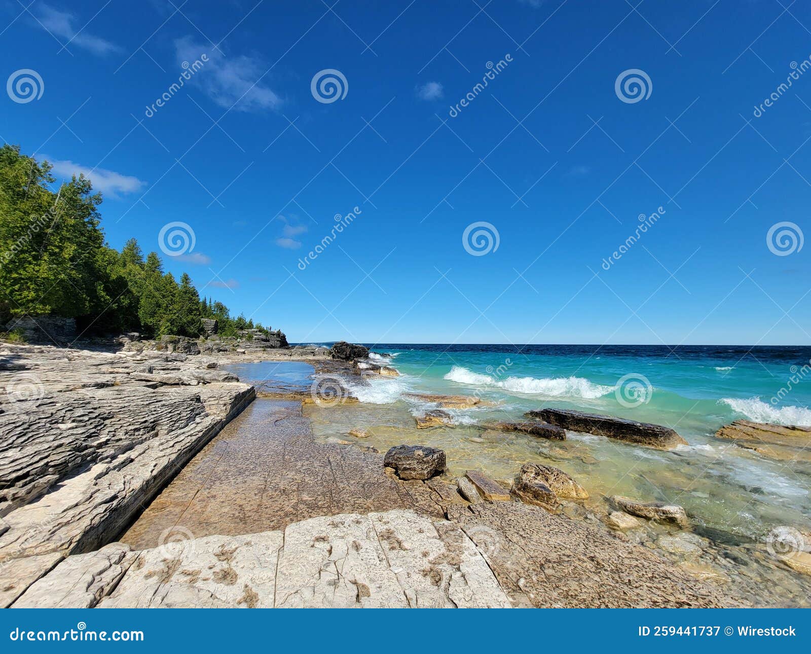Natural View of Rocky Cliff and Beautiful Coast Under a Sunny Day ... Natural View of Rocky Cliff and Beautiful Coast Under a Sunny Day ...
