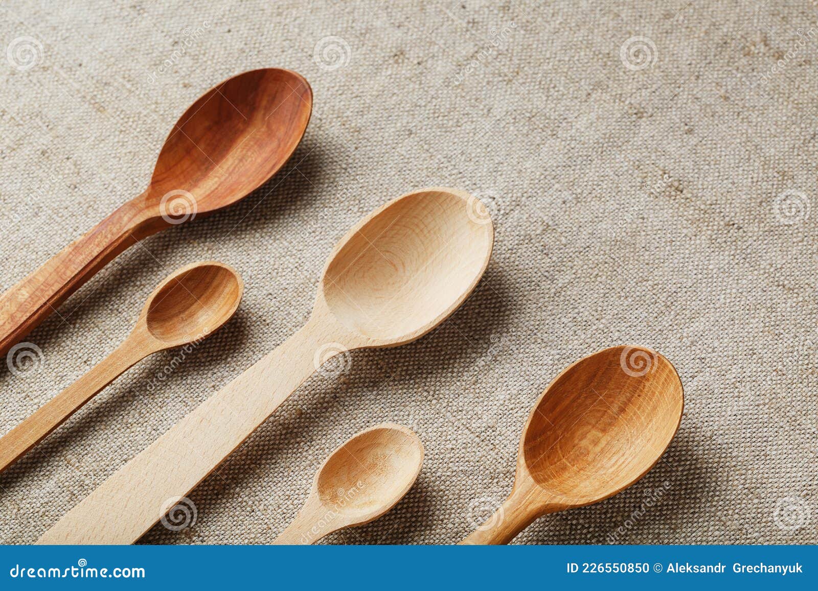 Natural Wood Spoons in a Row on Burlap Fabric. Natural Natural ...