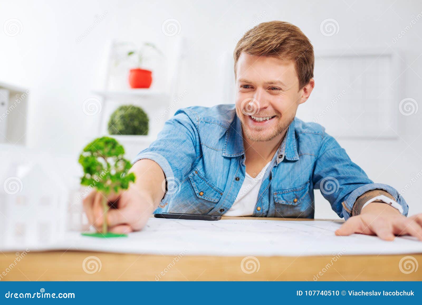Happy Engineer Moving Miniature Trees while Being at Work Stock Photo ...