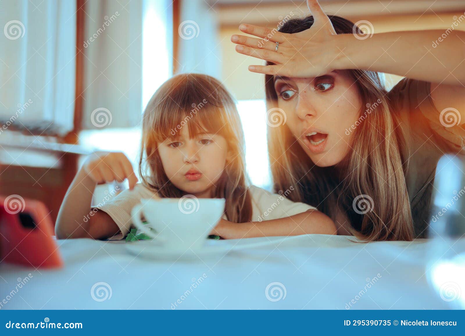 Naughty Daughter Playing with the Coffee Cup Exasperating Mom Stock ...