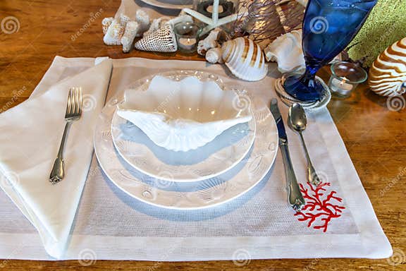 Nautical Place Setting with a Shell Dish on a Nautical Plate Stock ...