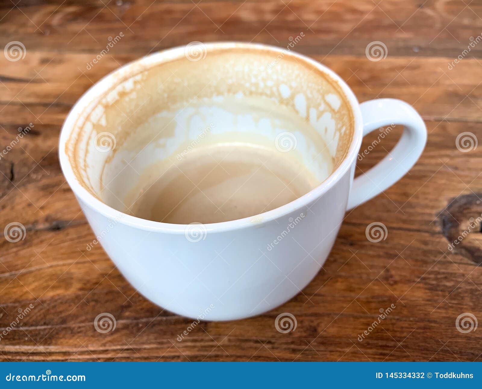Nearly Empty Coffee Mug on a Wooden Background Stock Photo - Image of ...