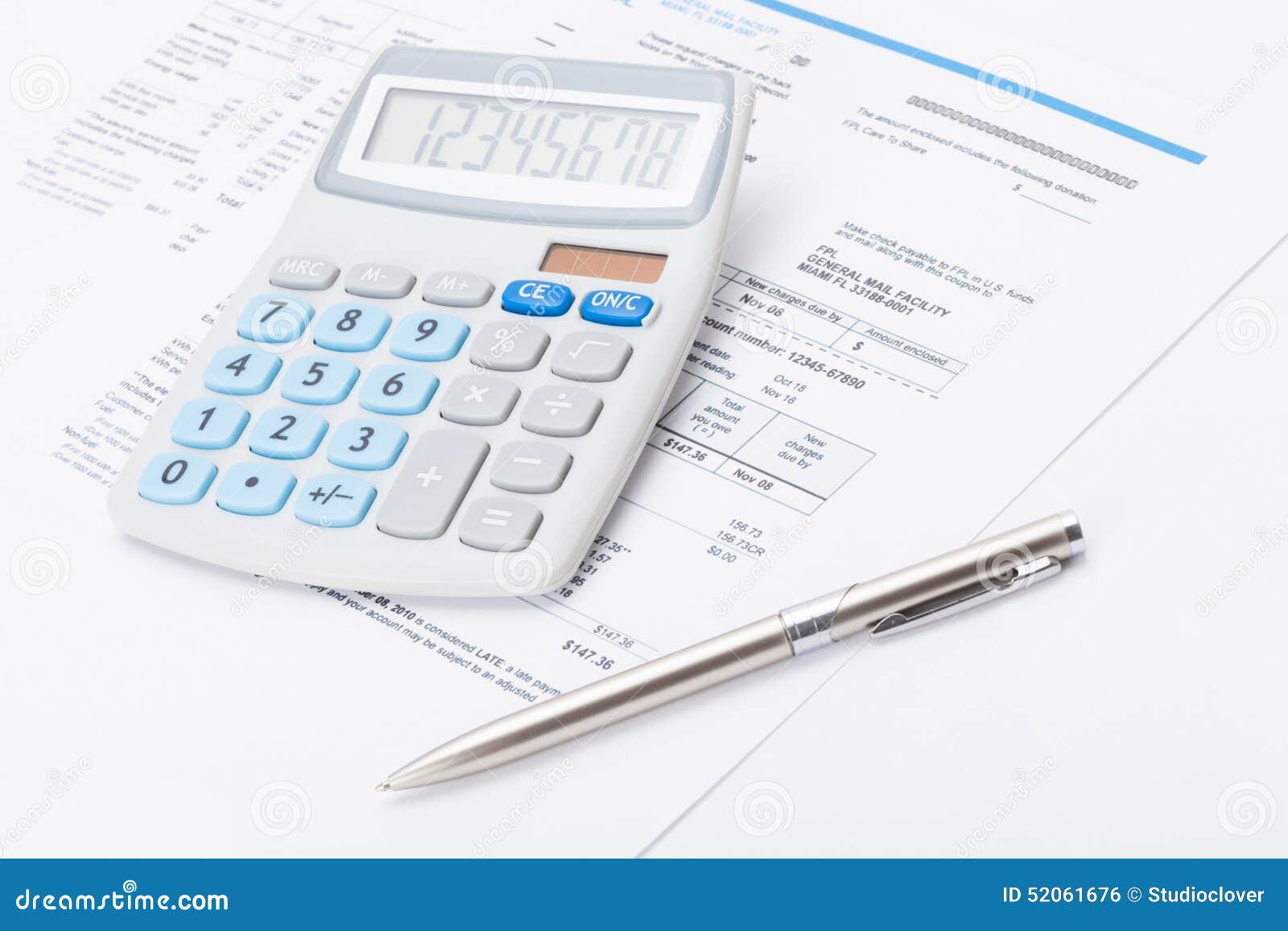 Neat Calculator with Silver Pen and Utility Bill Under it Stock Photo ...