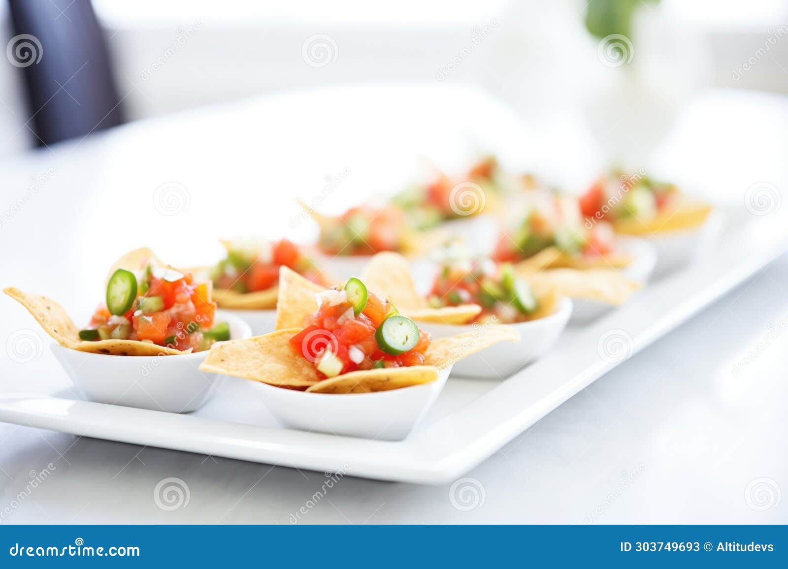 A Neat Row of Chips with Salsa Dollops on Top, Clean White Platter ...