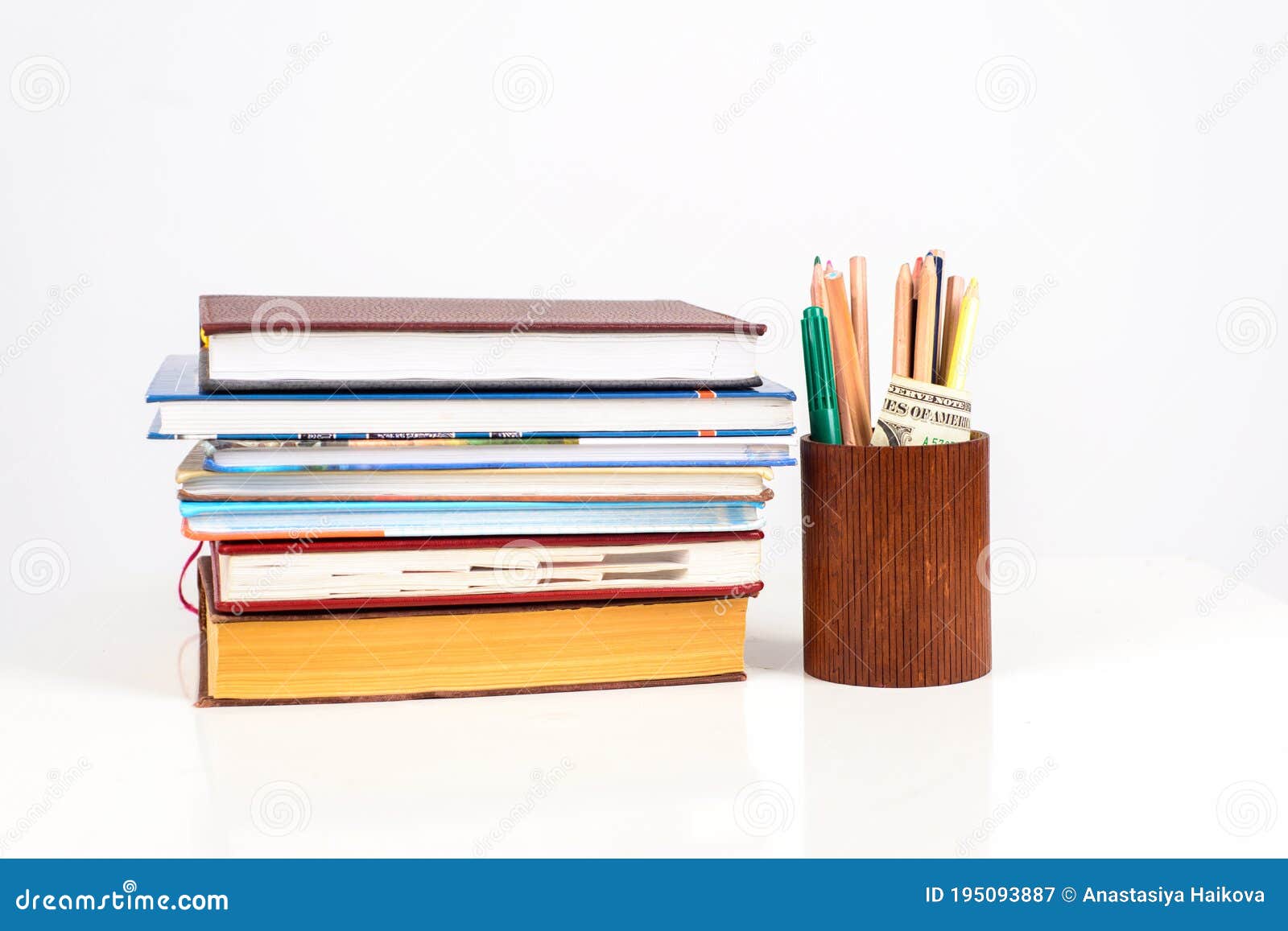 A Neat Stack of Colorful Books with School Supplies on Table Stock ...