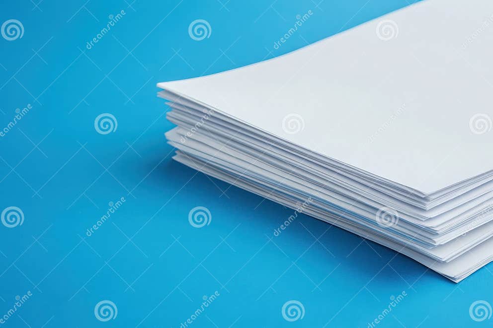 Unfinished Paperwork Stacked Neatly on a Solid Blue Surface in a Well ...