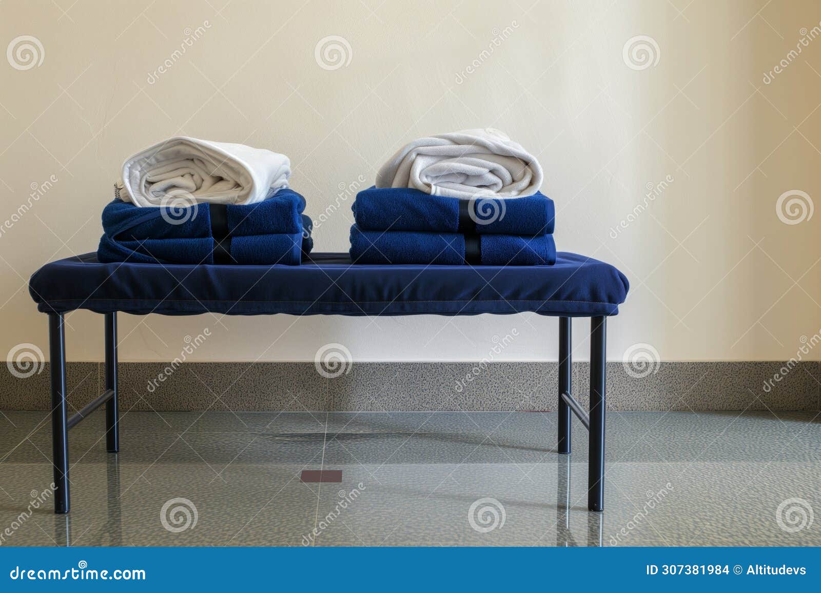 Neatly Folded Robes on a Bench with a Plain Backdrop for Text Stock ...