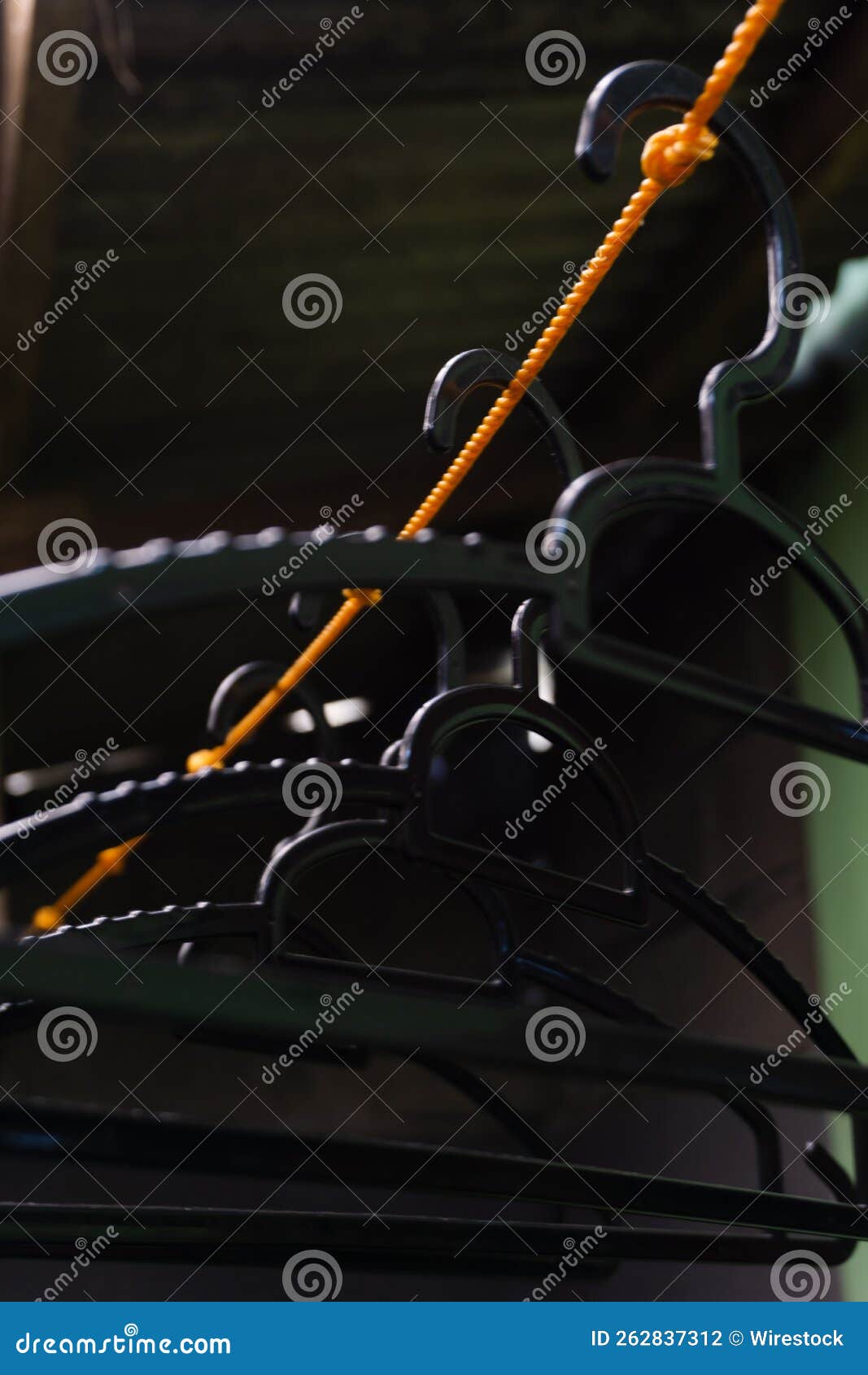 Neatly Lined Clothes Hangers on a Rope Stock Photo - Image of lined ...