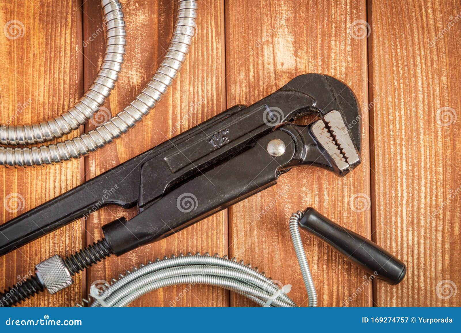 Necessary Set of Tools and Hose for Master Plumber on Old Wooden Boards ...