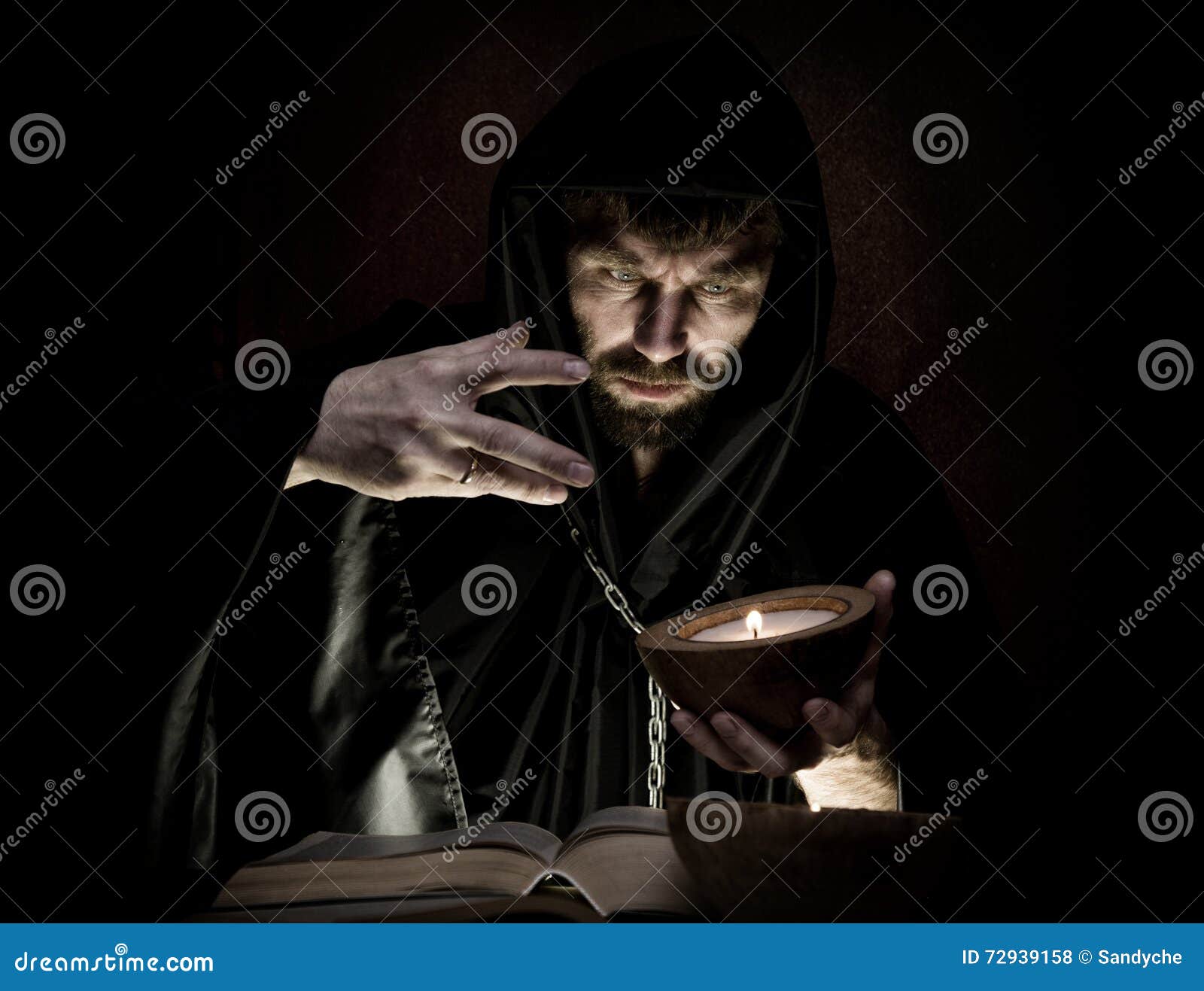Necromancer Casts Spells From Thick Ancient Book By Candlelight On A ...