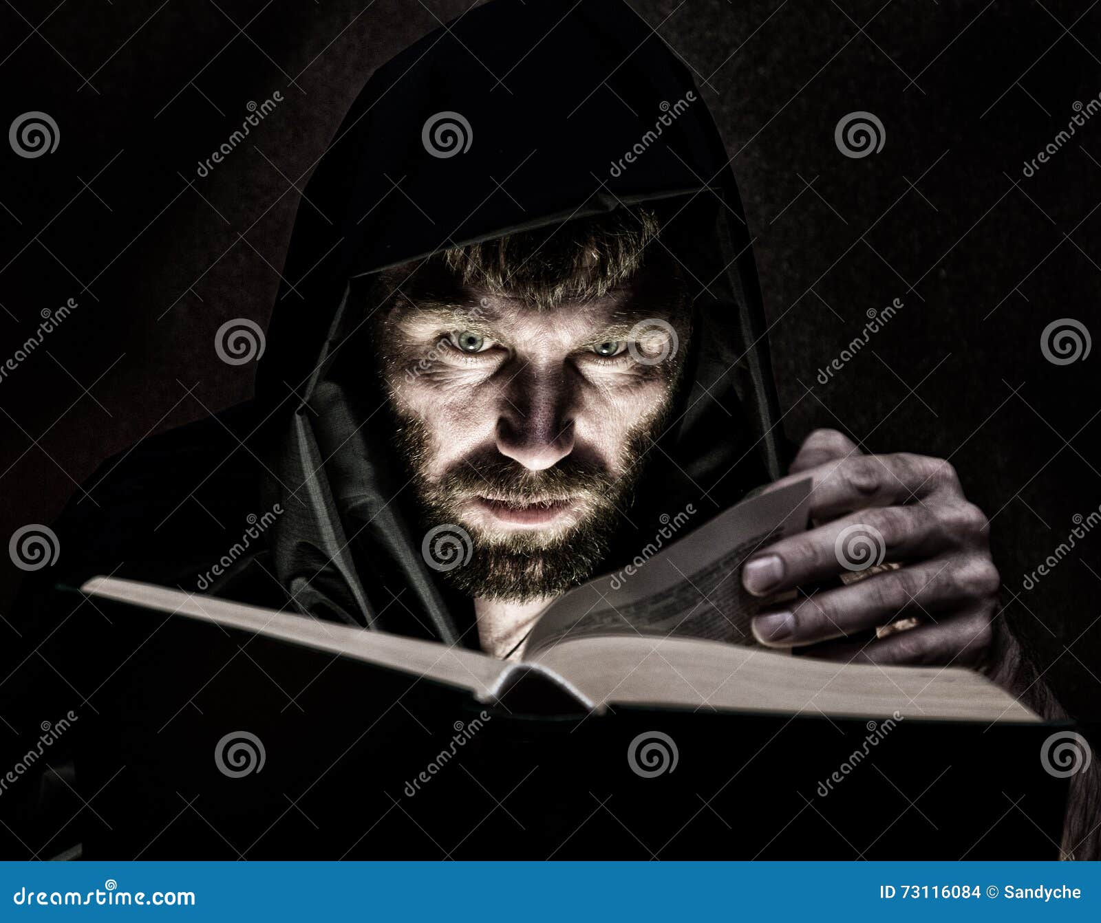Necromancer Casts Spells From Thick Ancient Book By Candlelight On A ...