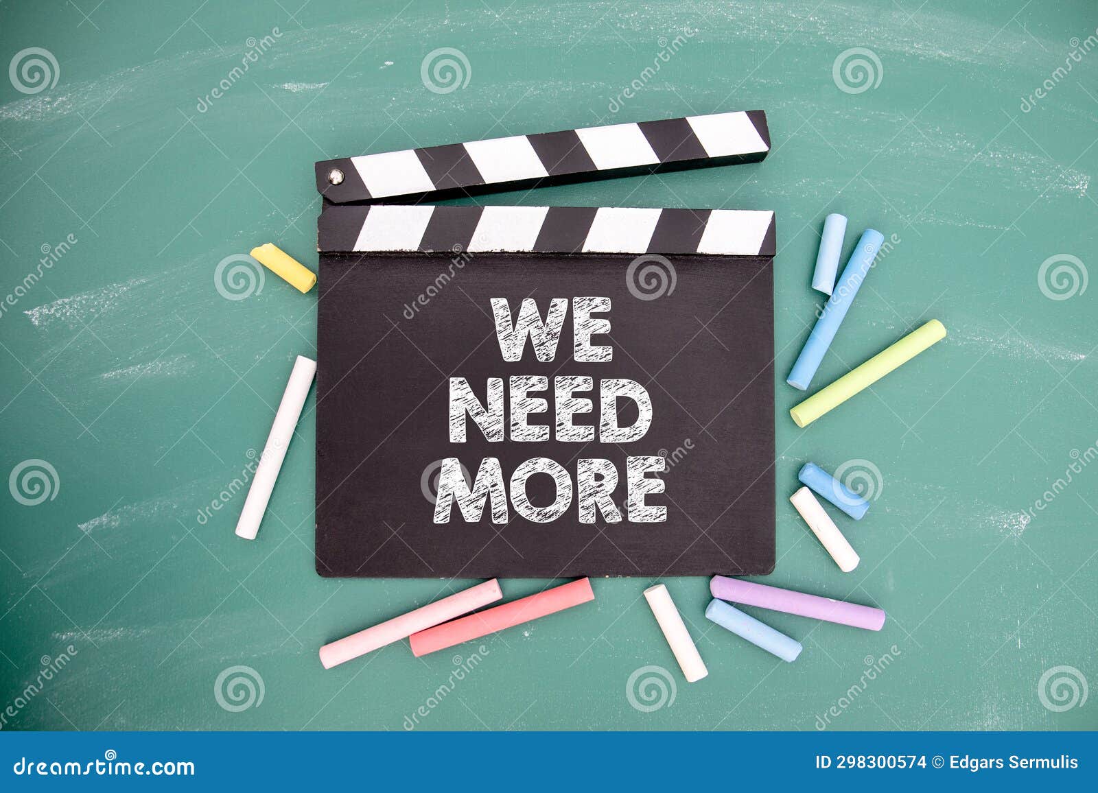 We Need More. Movie Clapper and Colored Pieces of Chalk Stock Photo ...