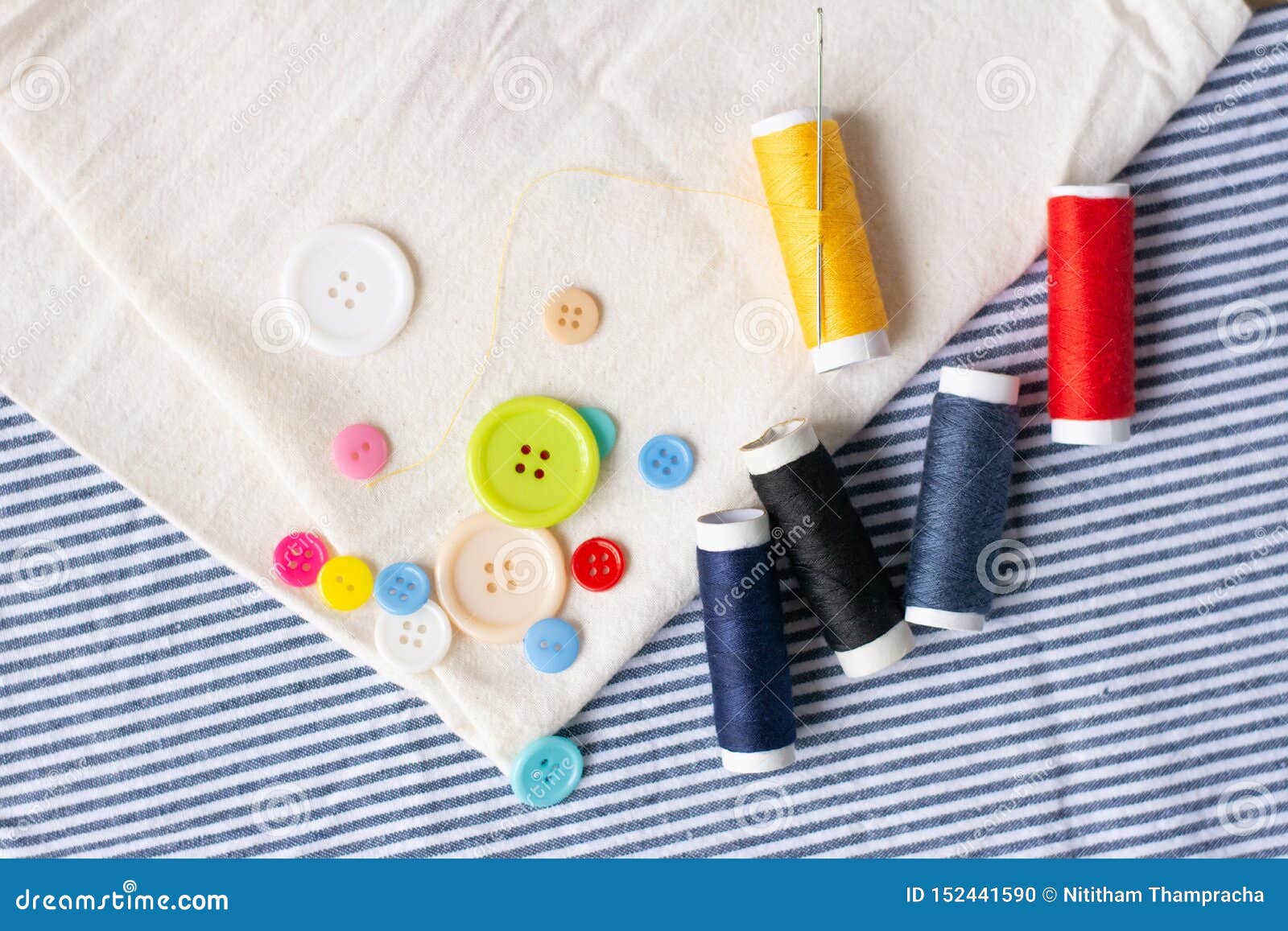 Needle, Buttons and Thread are on the Cotton. Stock Photo - Image of ...