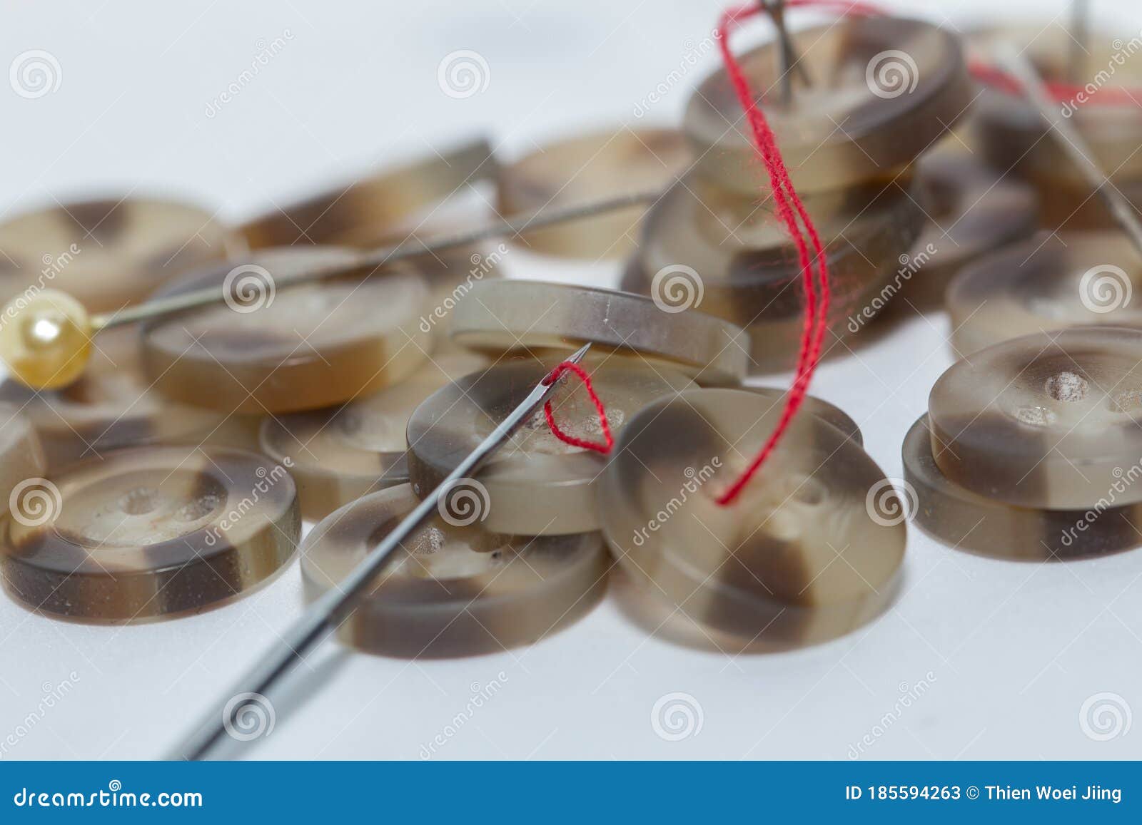Needle with Thread and Button Isolated on White Stock Image - Image of ...
