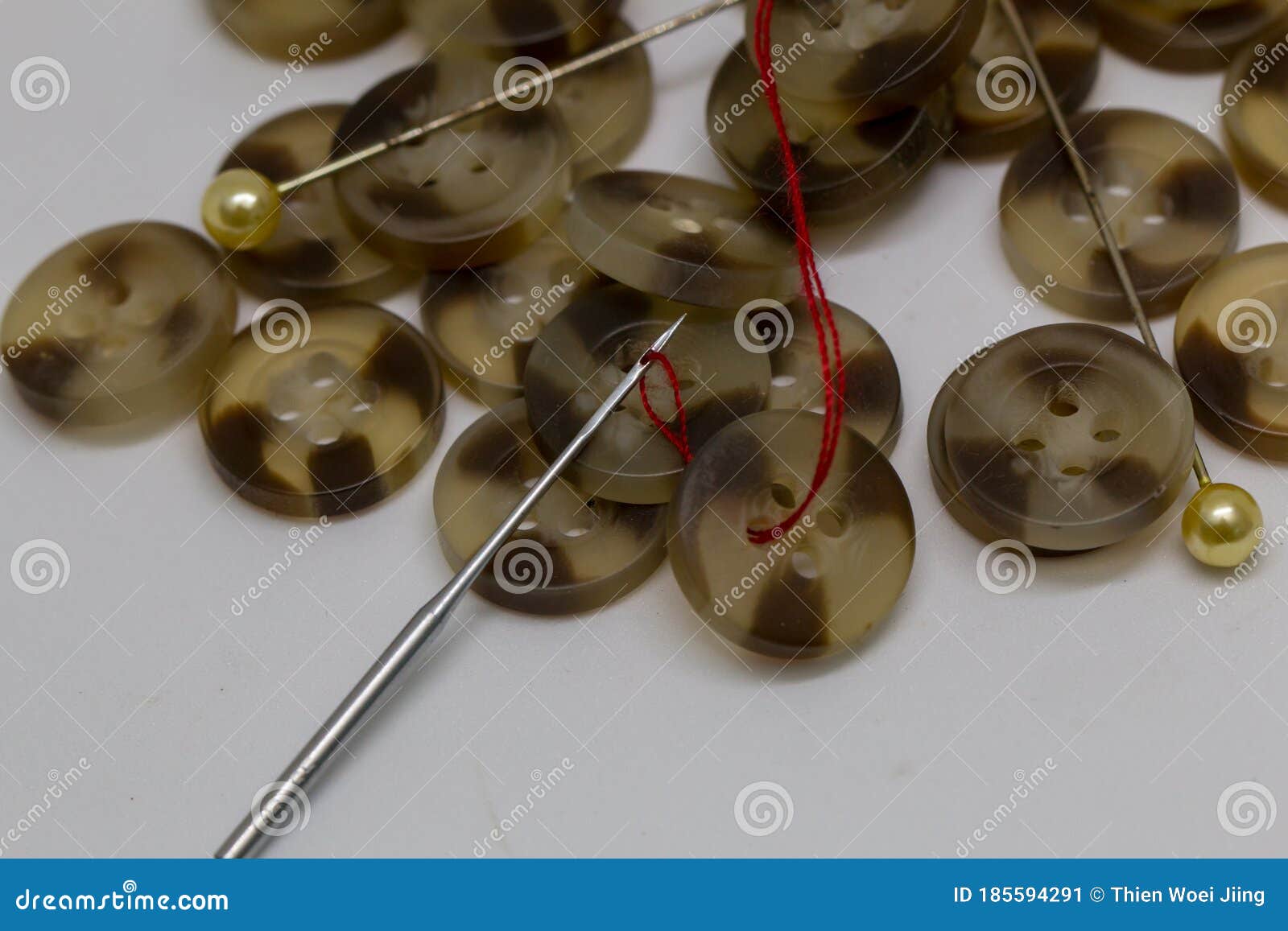 Needle with Thread and Button Isolated on White Stock Image - Image of ...