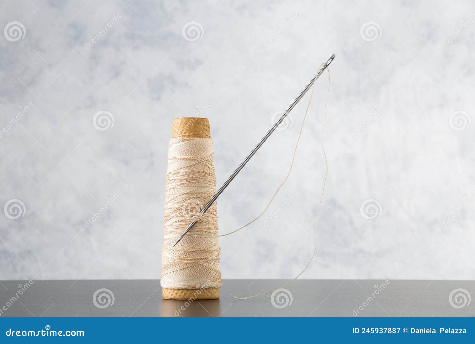 Needle and Thread on a Table Stock Image - Image of backdrop, spool ...