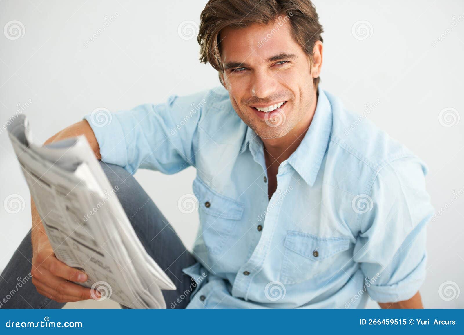 He always Needs His Morning Read. a Handsome Young Man Sitting with a ...