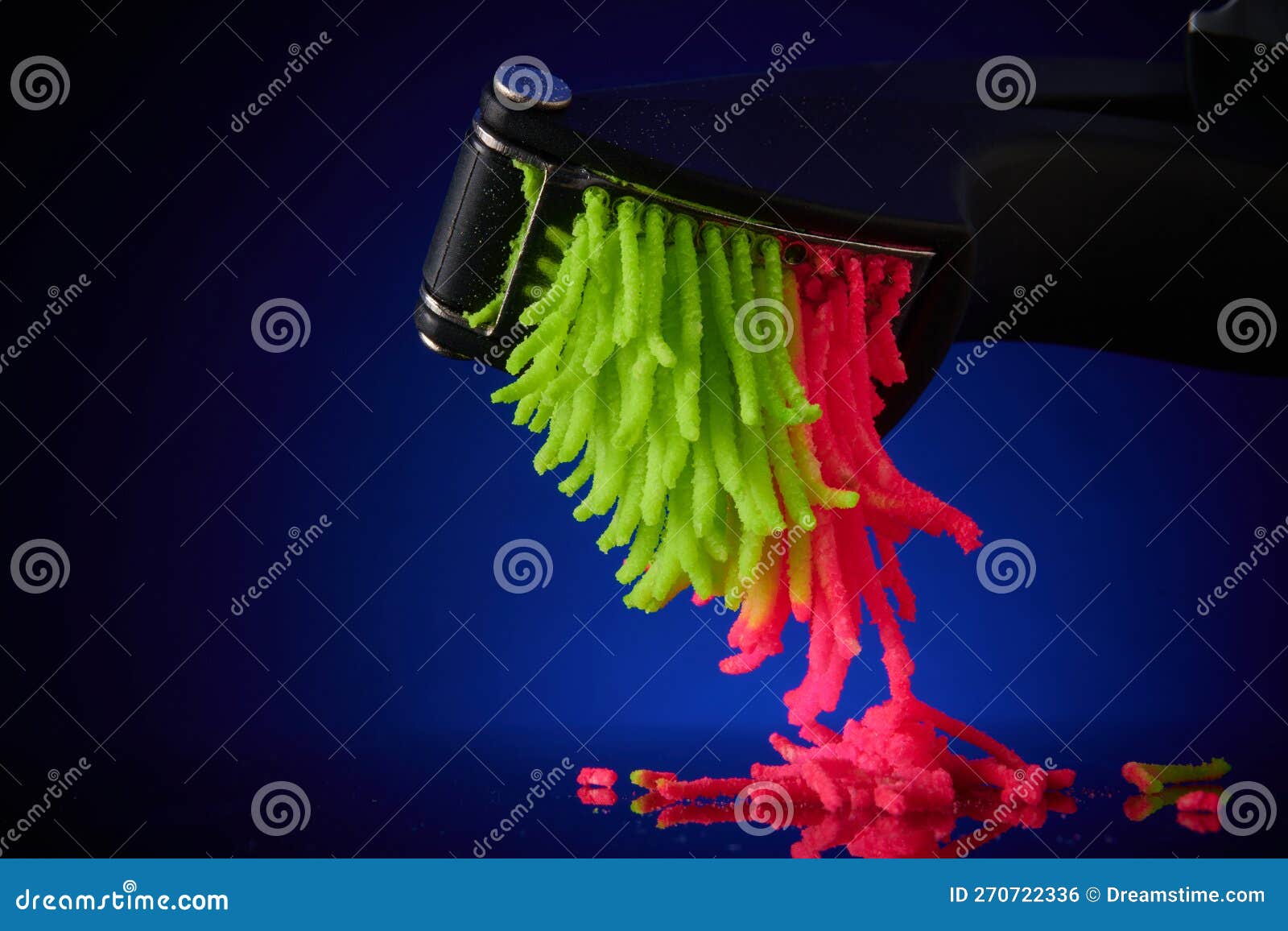 Garlic Press Oozing with Color Stock Photo - Image of strand, ooze ...