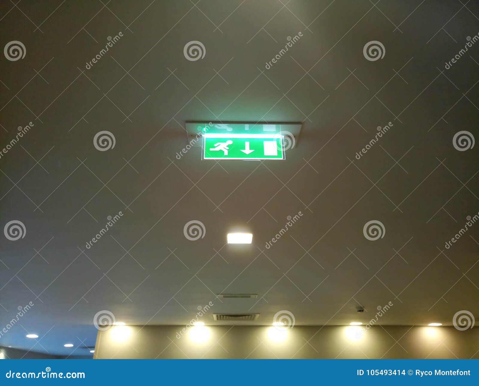 Neon Green Fire Exit Sign on a High Ceiling Stock Photo - Image of ...
