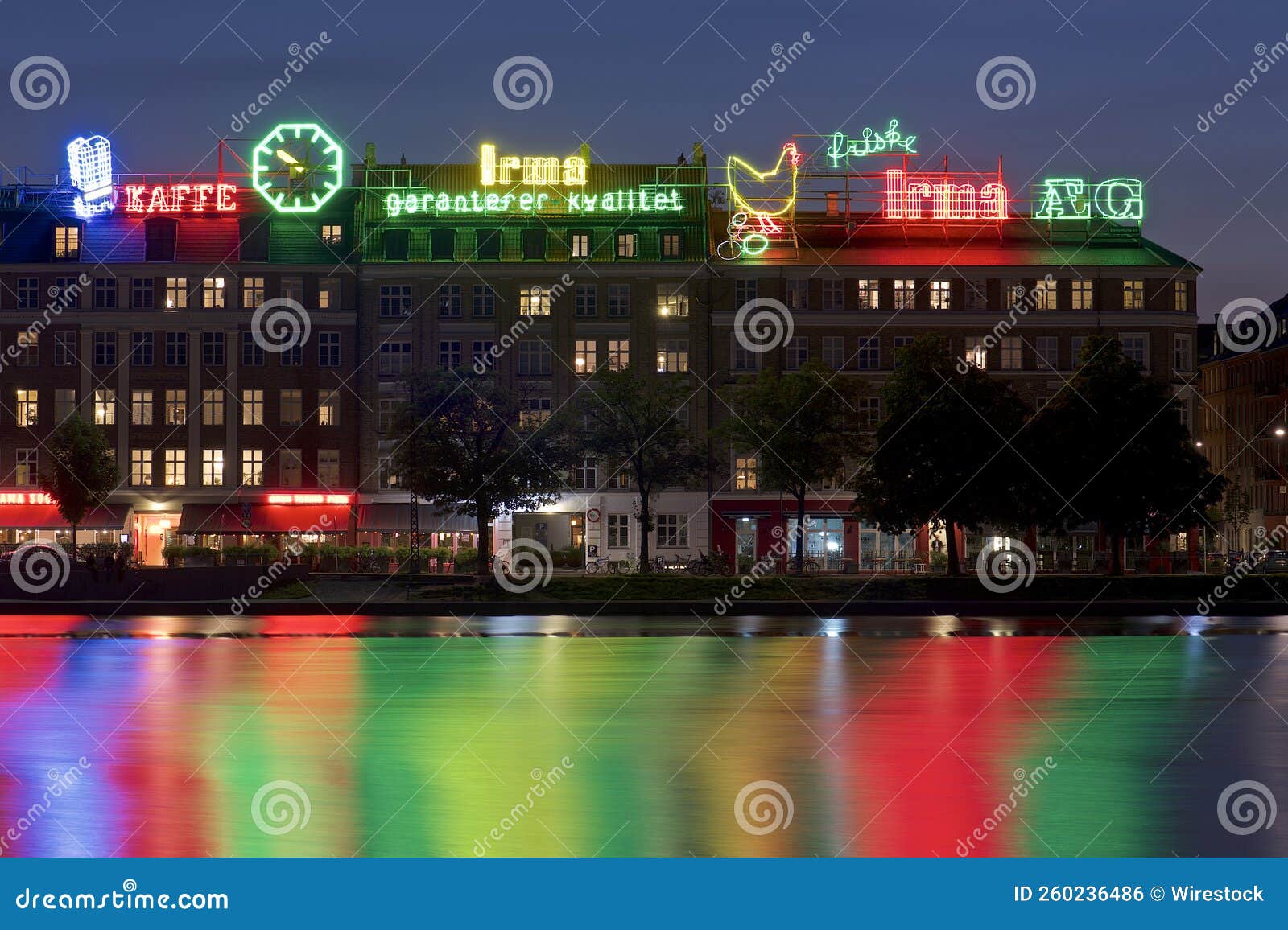 Neon Lights of Irma-Honen Reflected in the Lake in Copenhagen, Denmark ...