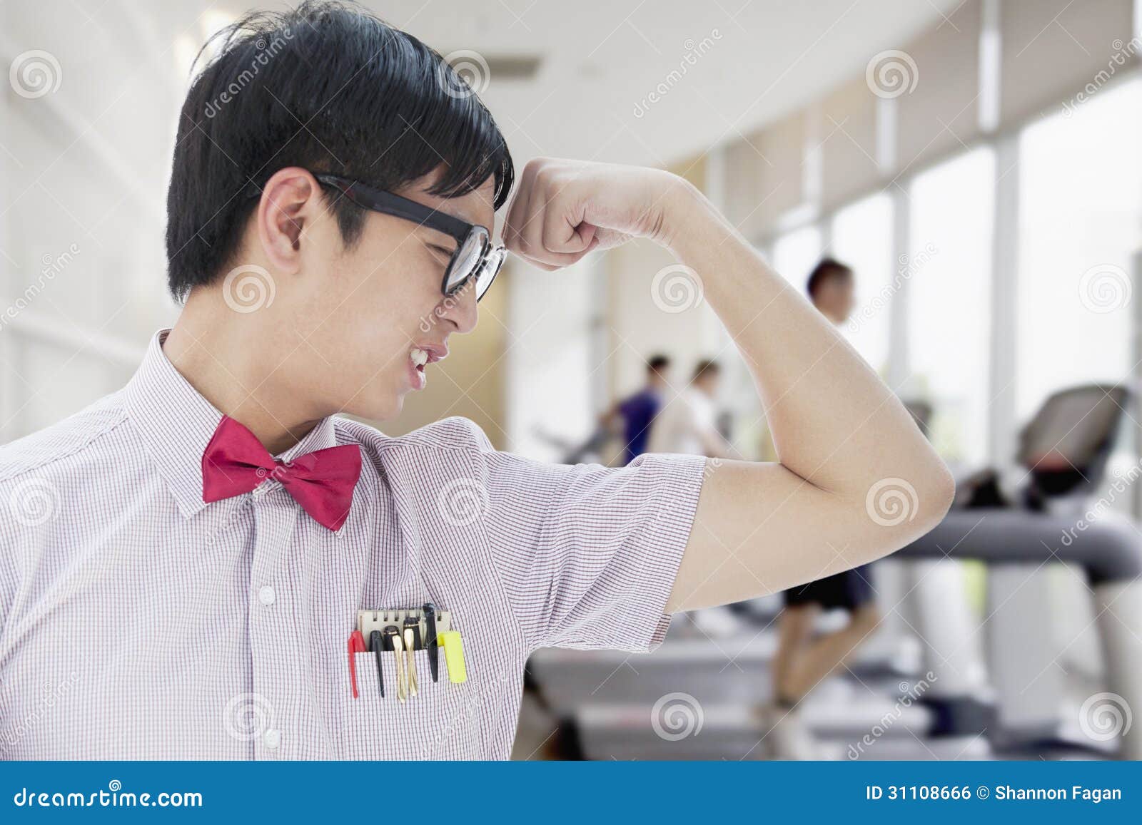 Nerdy Man with Glasses Flexing His Bicep in the Gym Stock Photo - Image ...