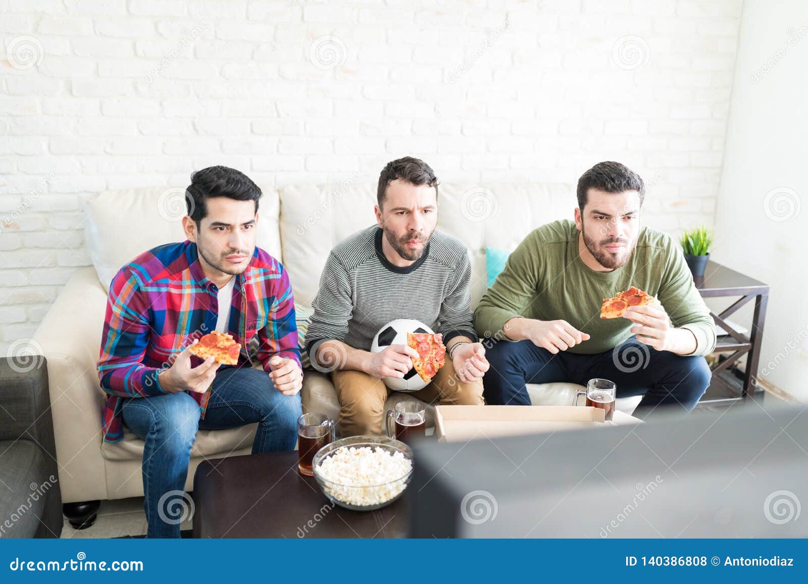 Nervous Friends Sitting in Front of TV during Soccer Match Stock Photo ... Nervous Friends Sitting in Front of TV during Soccer Match Stock Photo ...