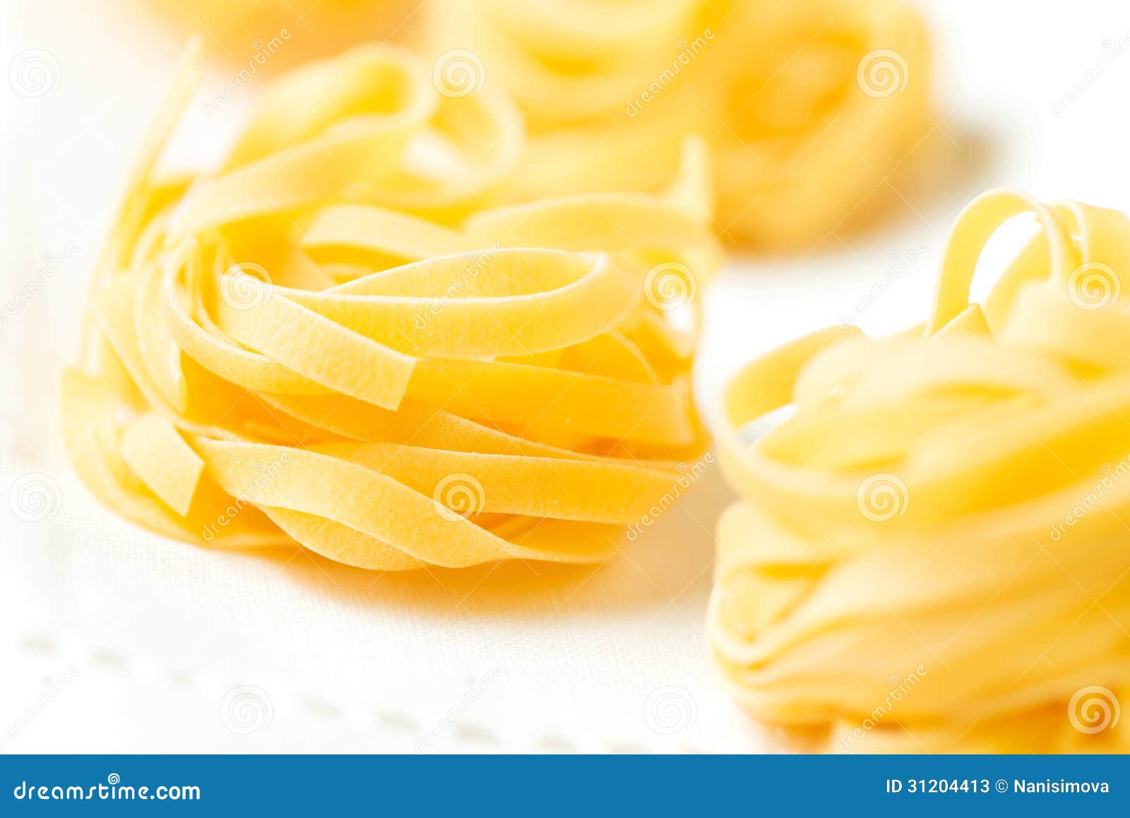 Nests of Dry Pasta Tagliatelle on Tablecloth Close Up Stock Image ...