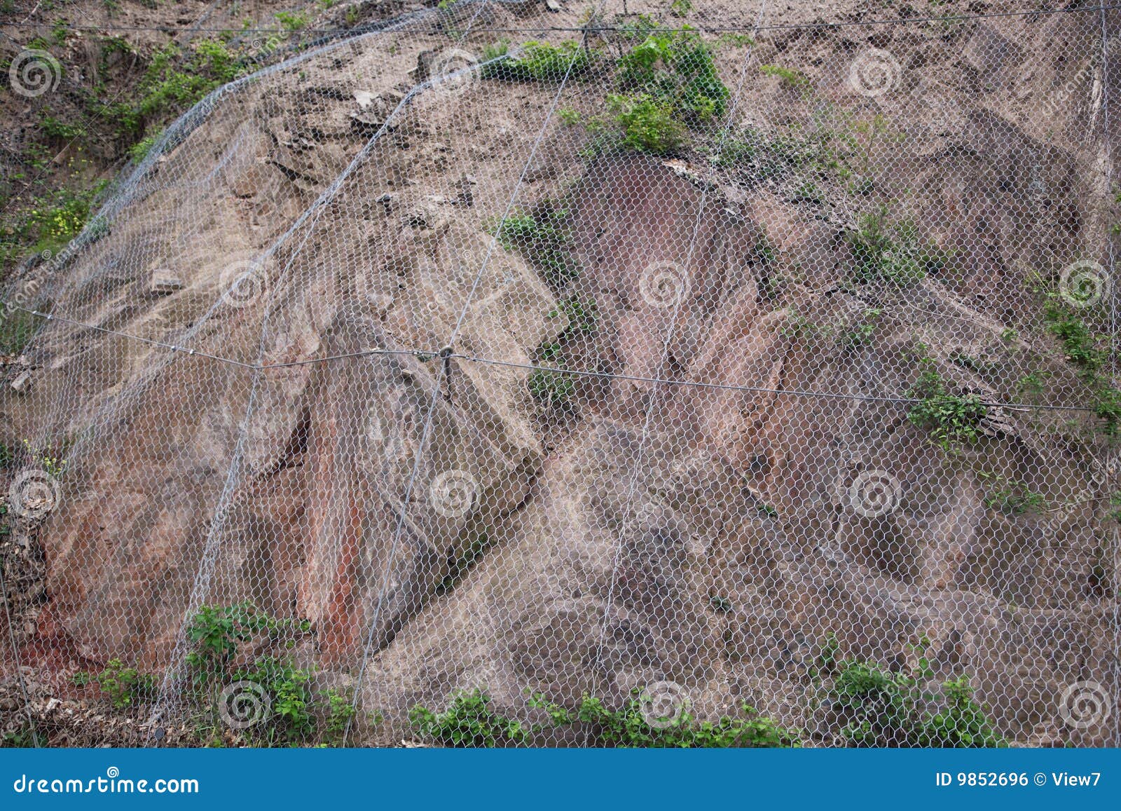 Netting over loose rocks stock photo. Image of danger - 9852696