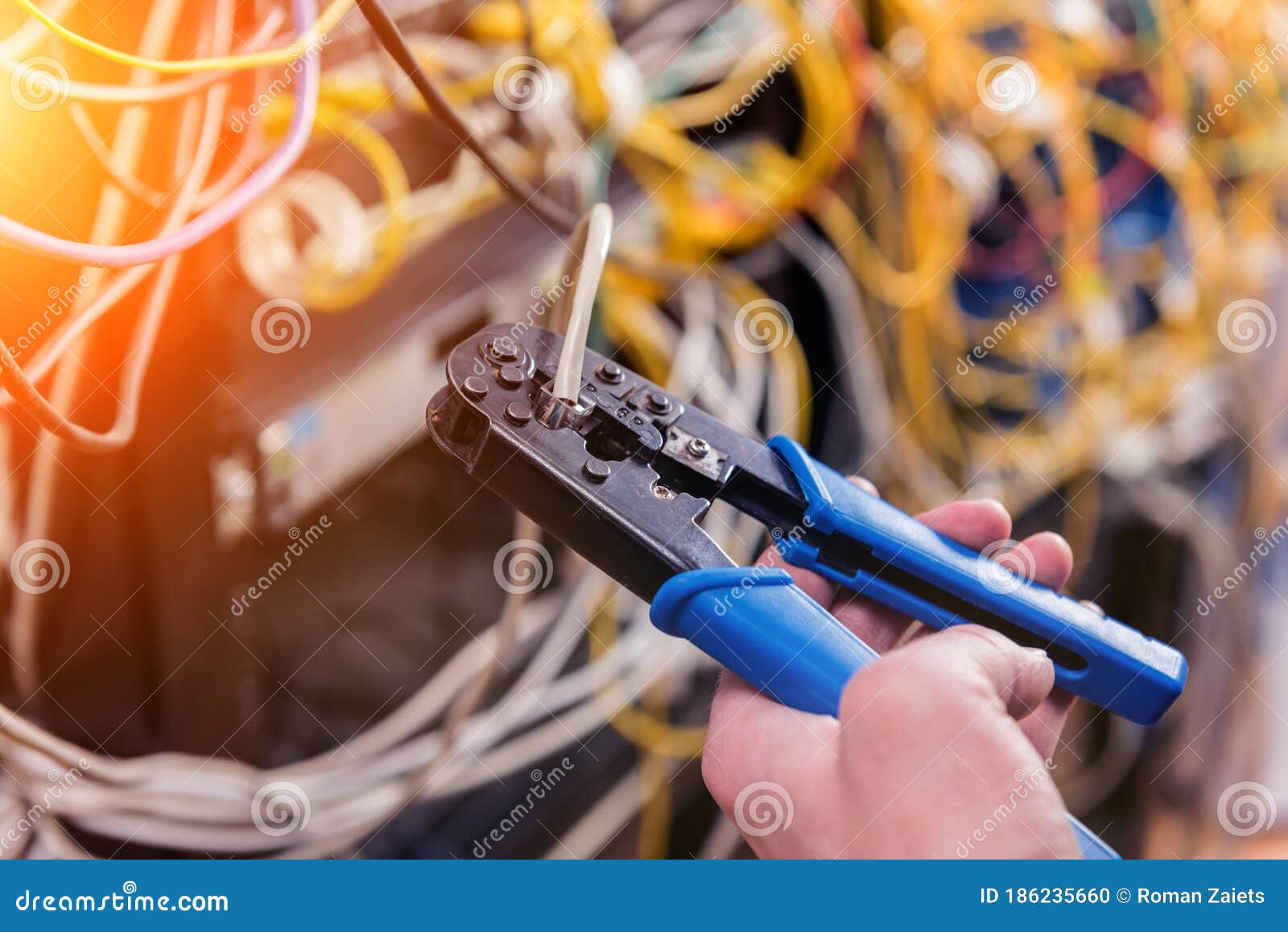 Network Engineer Working in Server Room. Connecting Network Cables To ...