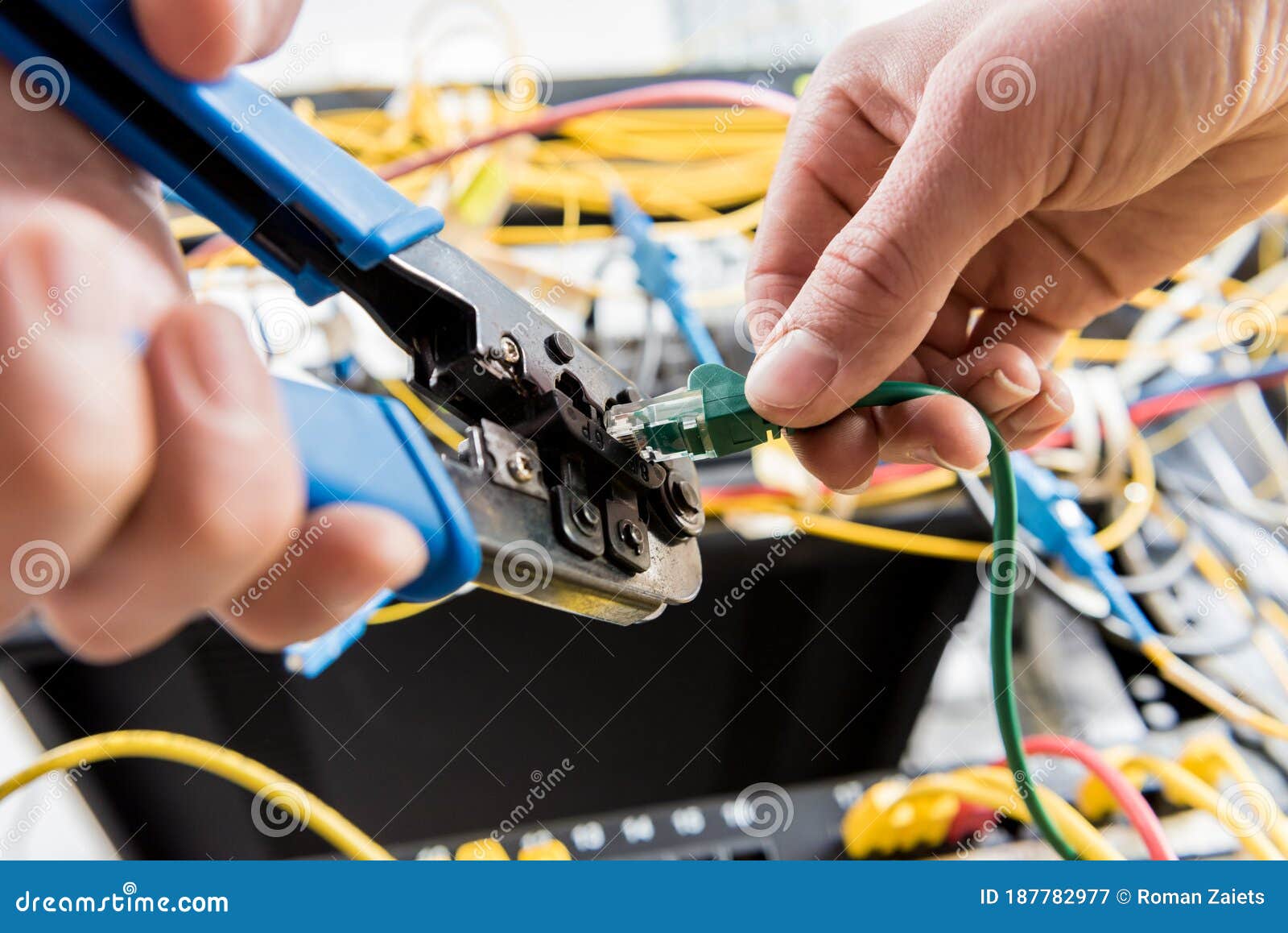 Network Engineer Working in Server Room. Connecting Network Cables To ...