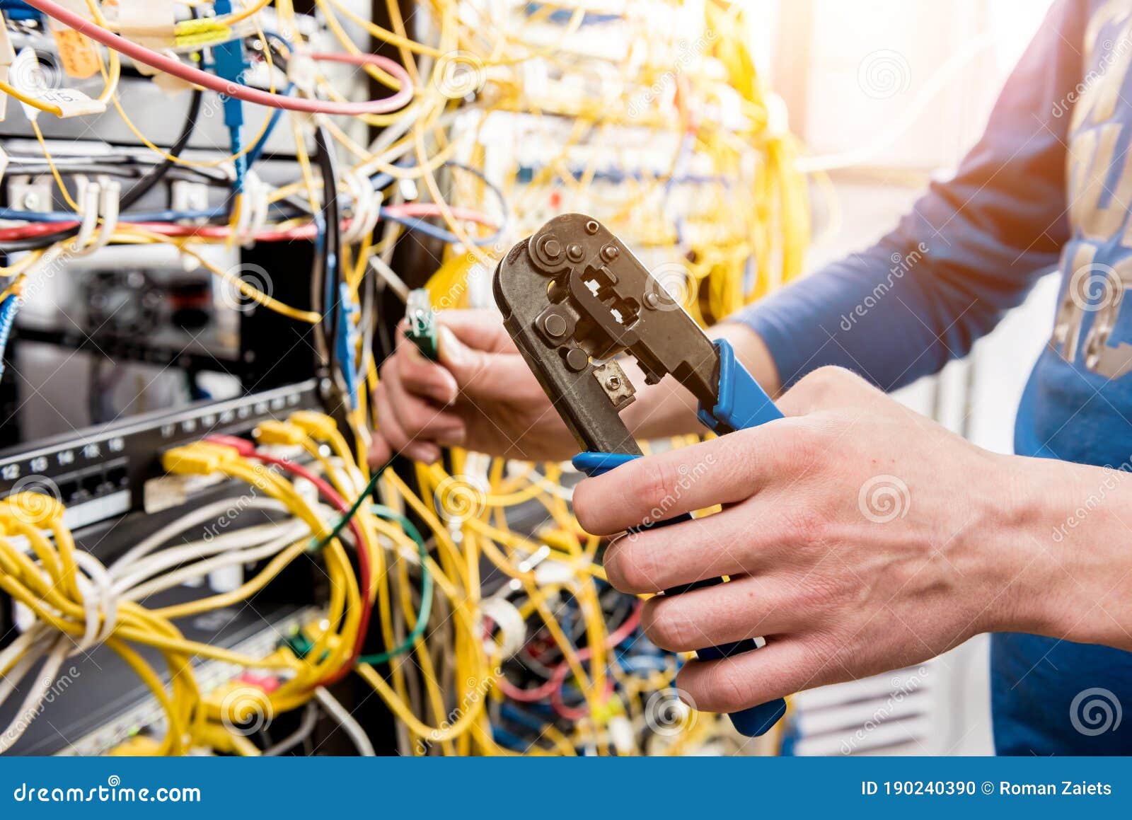 Network Engineer Working in Server Room. Connecting Network Cables To ...