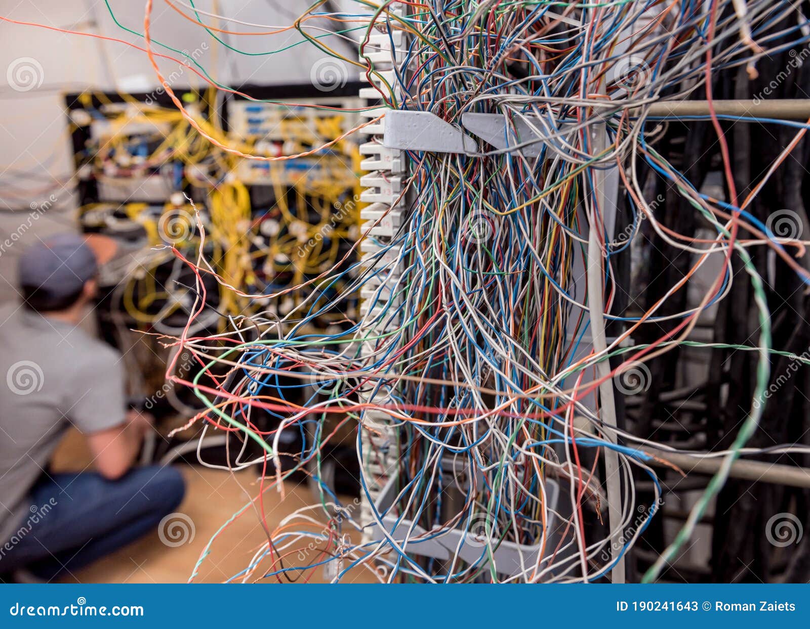 Network Engineer Working in Server Room. Connecting Network Cables To ...