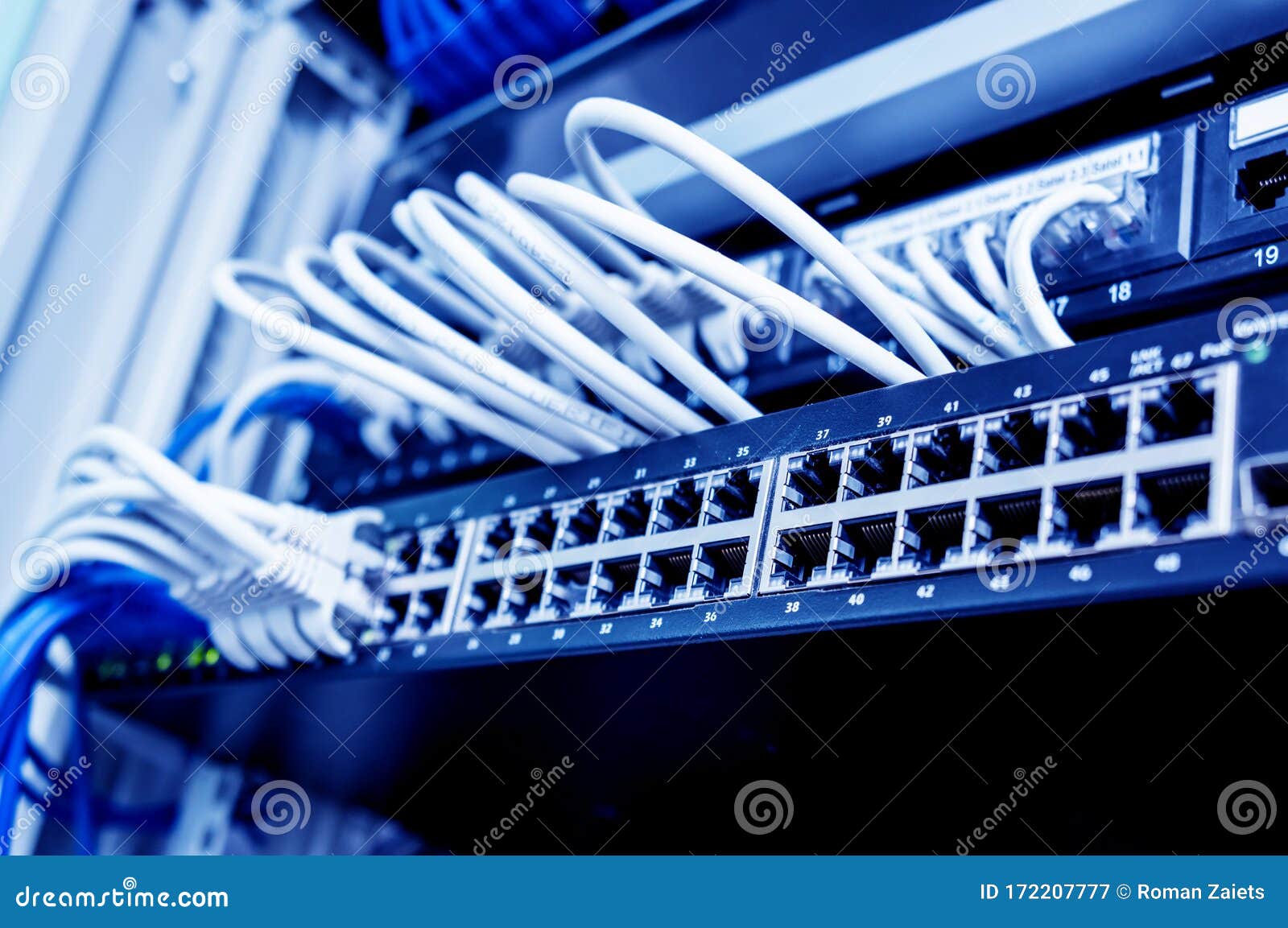 Network Switch and Ethernet Cables in Red and White Colors. Data Center ...