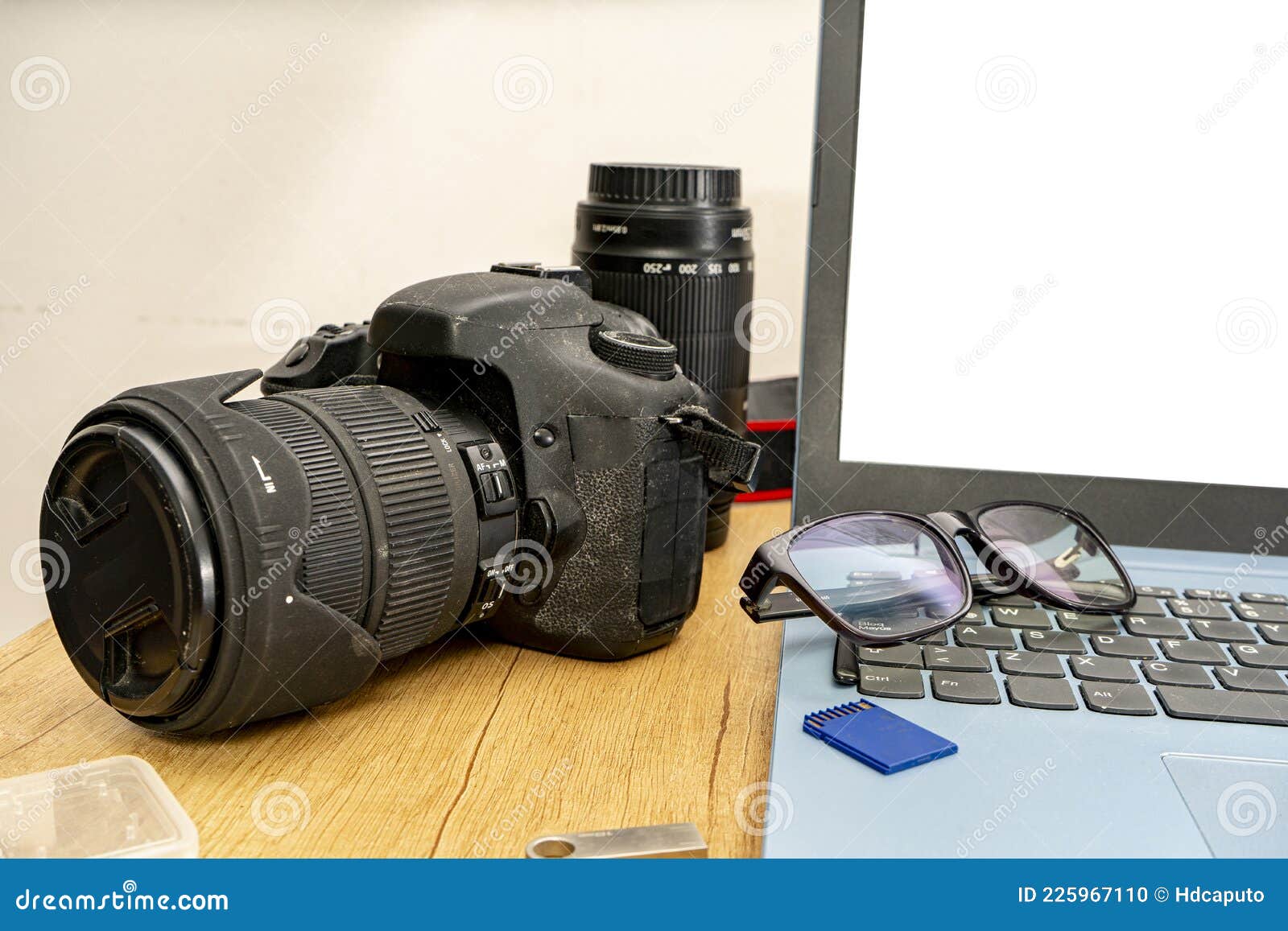 Neutral View of an Open Laptop with a Reflex Camera and a Pair of ...