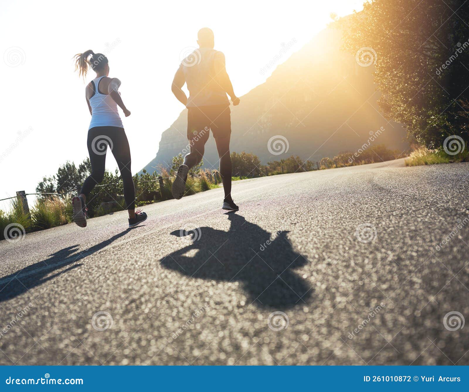 Never on Time, but always on Pace. Low Angle Shot of Two People Running ...