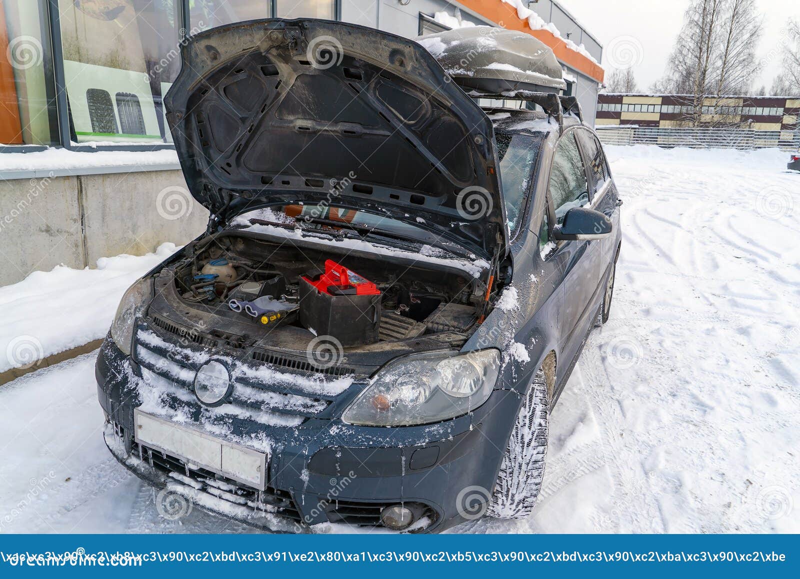 A New Battery in the Engine Compartment of the Car in Winter. Stock ...