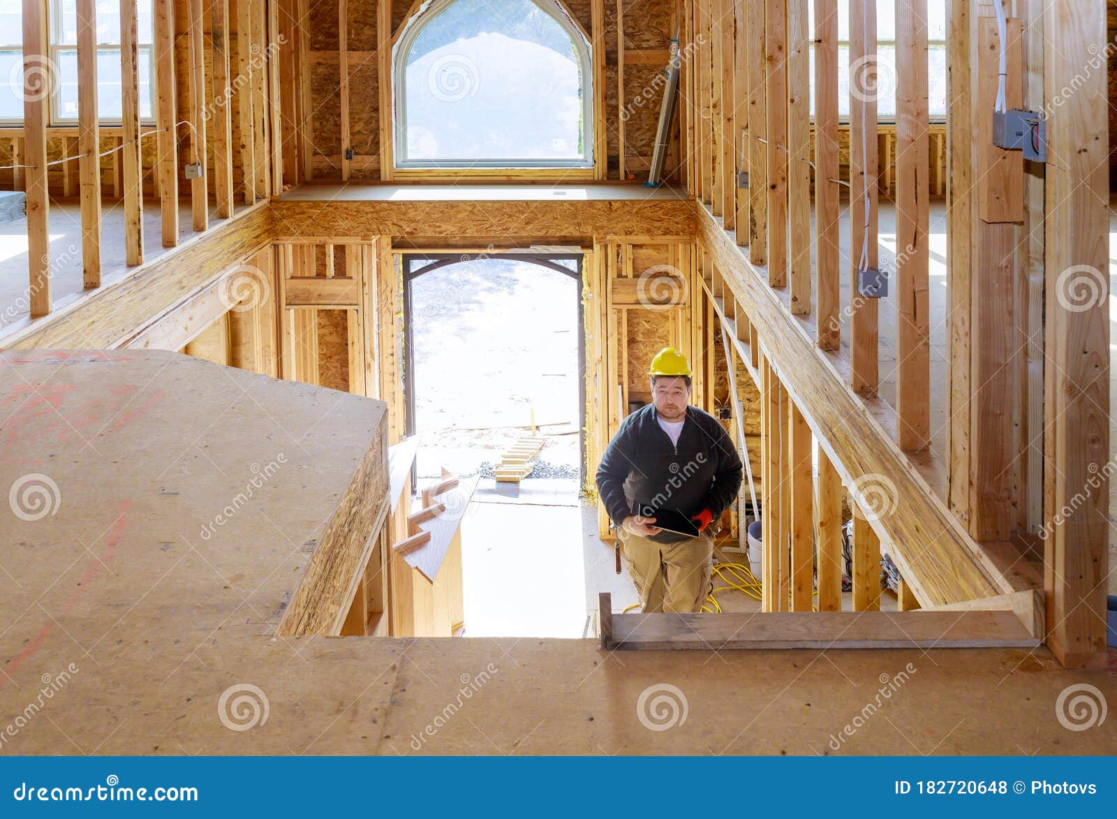 New Construction House Builder in Hard Hat Walking on Holding Tablet PC ...