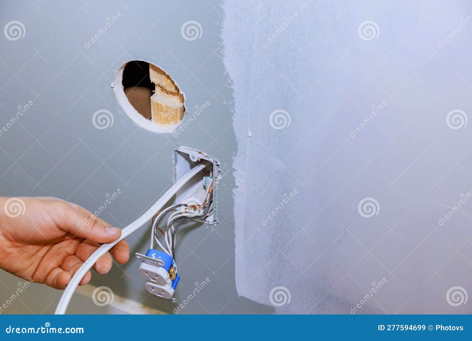 A New Current Socket is Installed by an Electrician on the Site of a ...