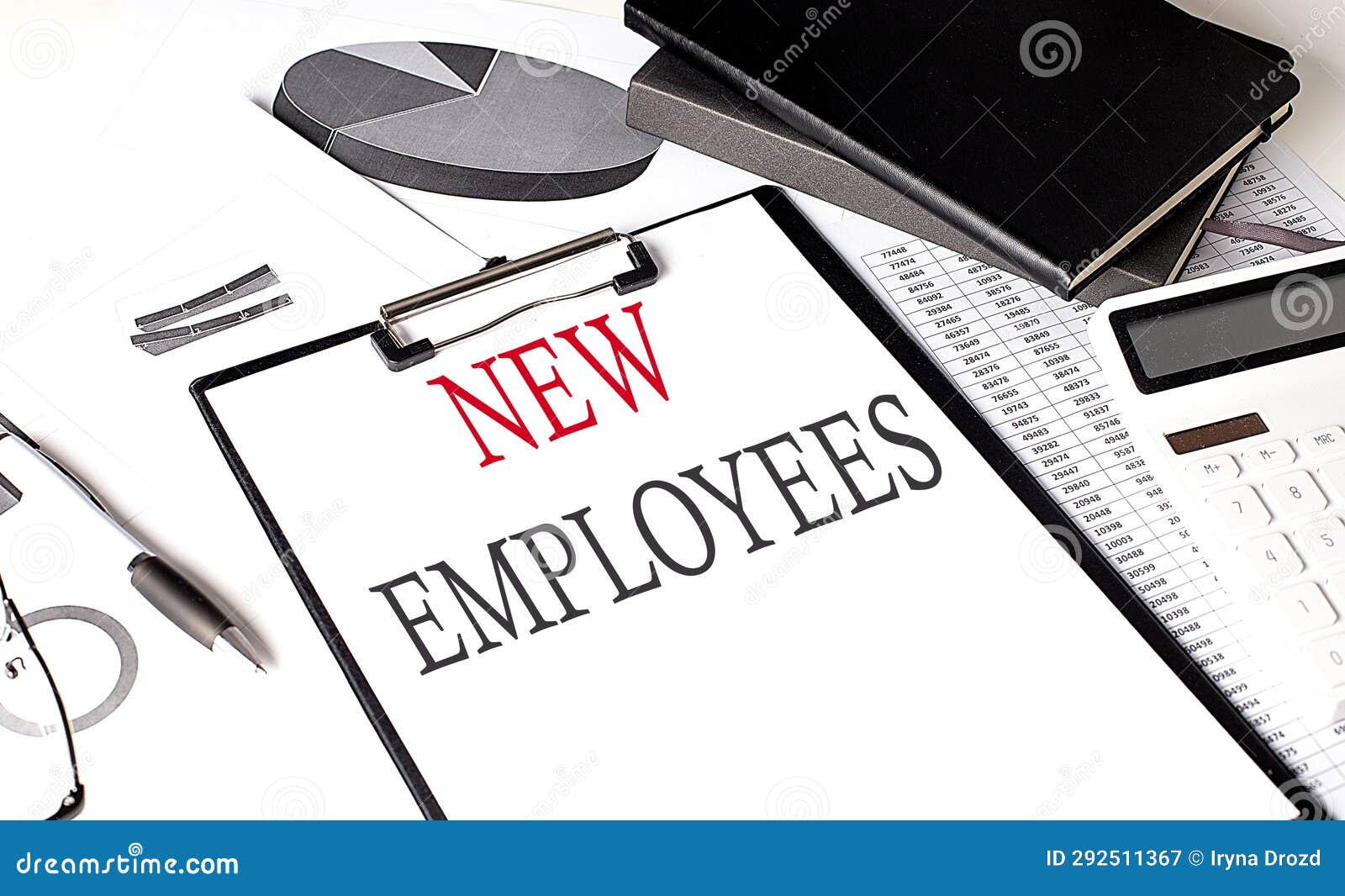 NEW EMPLOYEES Text on Paper Clipboard with Chart and Notebook on Withe ...