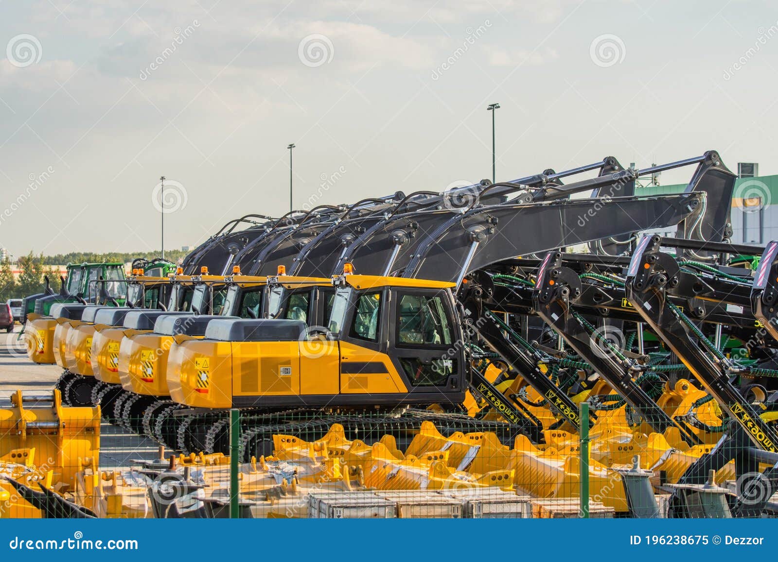 New Excavators are Lined Up in a Parking Lot Stock Image - Image of ...